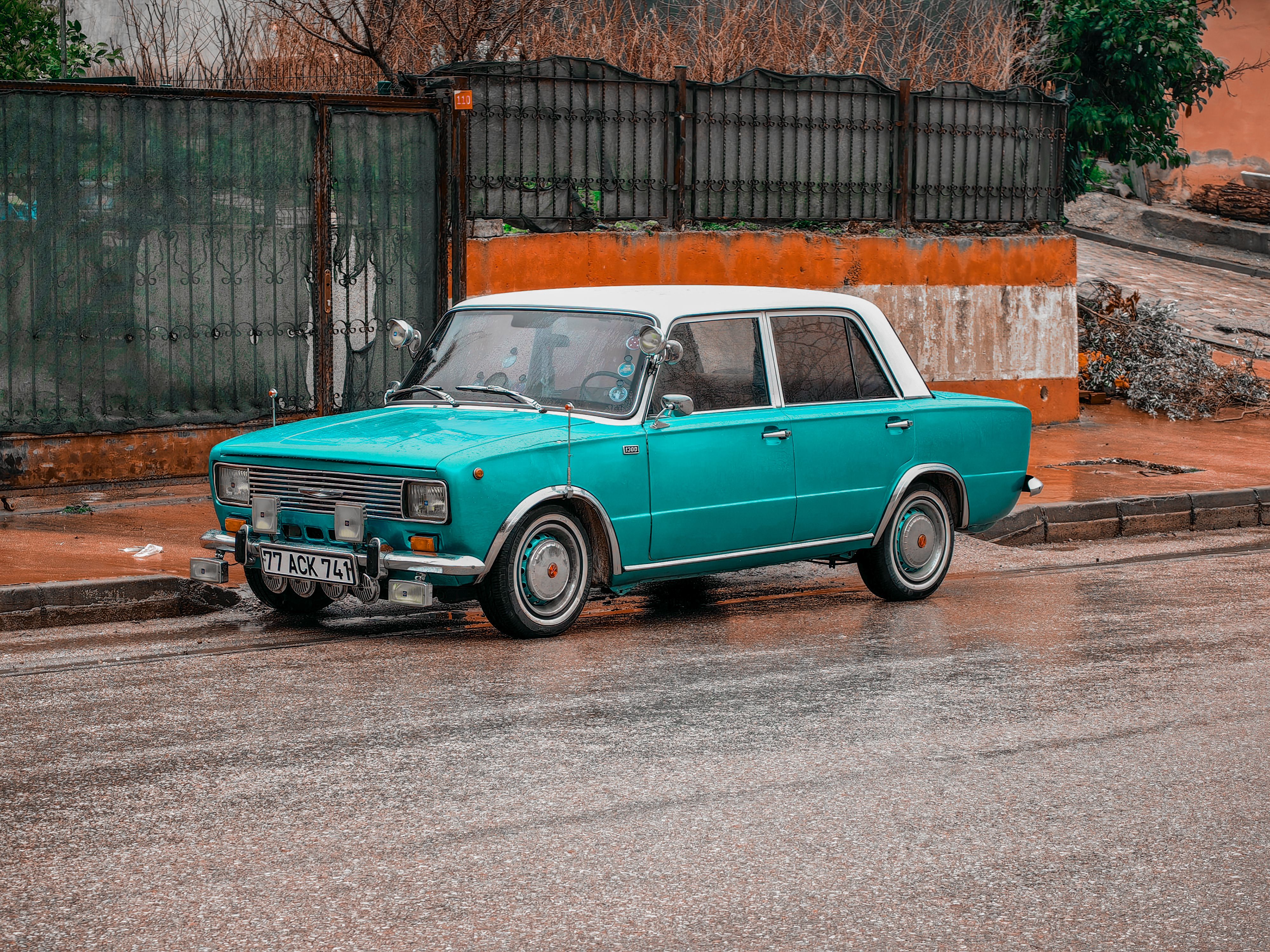 Vintage Turquoise Car on Rainy Street in Yalova · Free Stock Photo