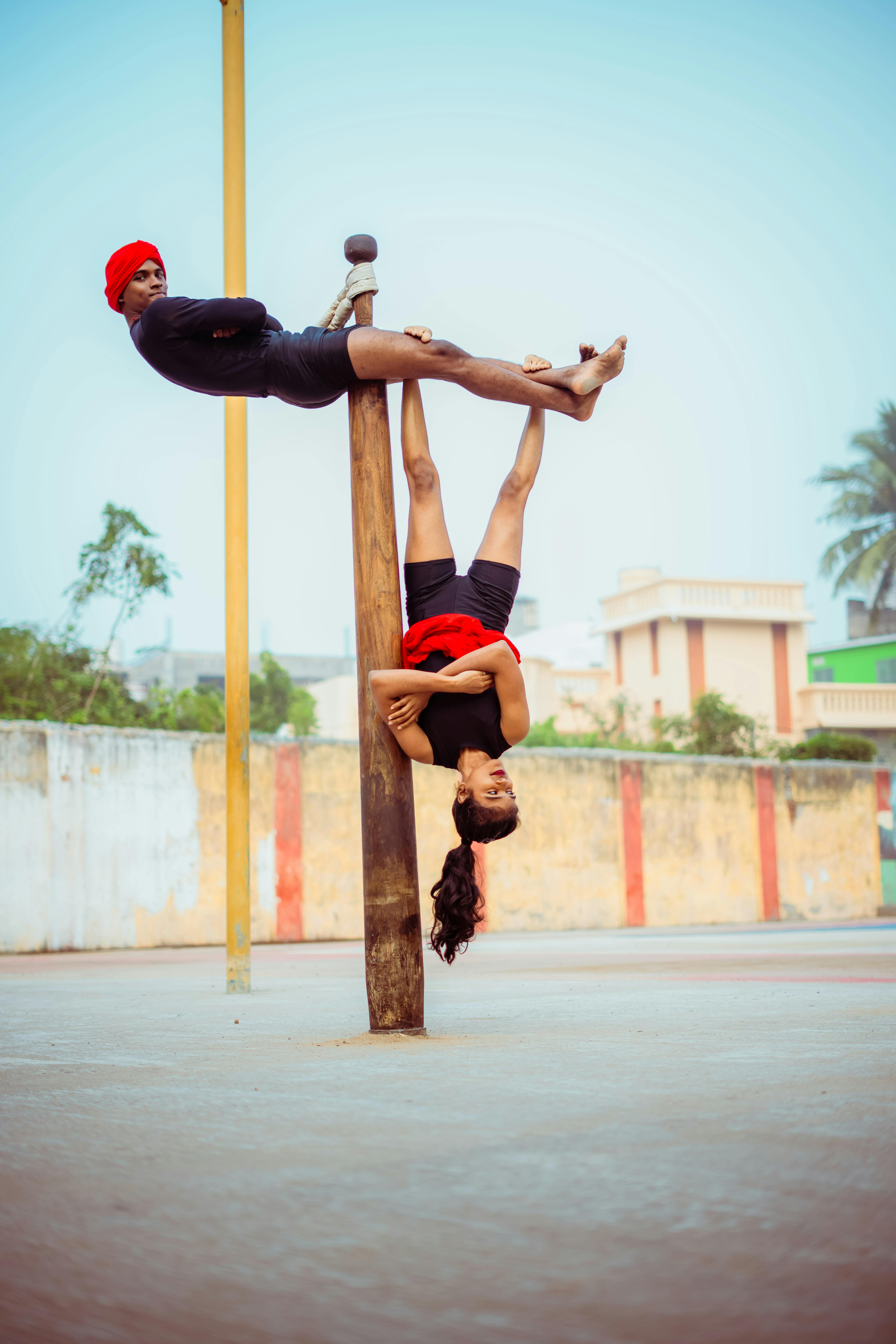 Dynamic Mallakhamb Duo Performance Outdoors · Free Stock Photo