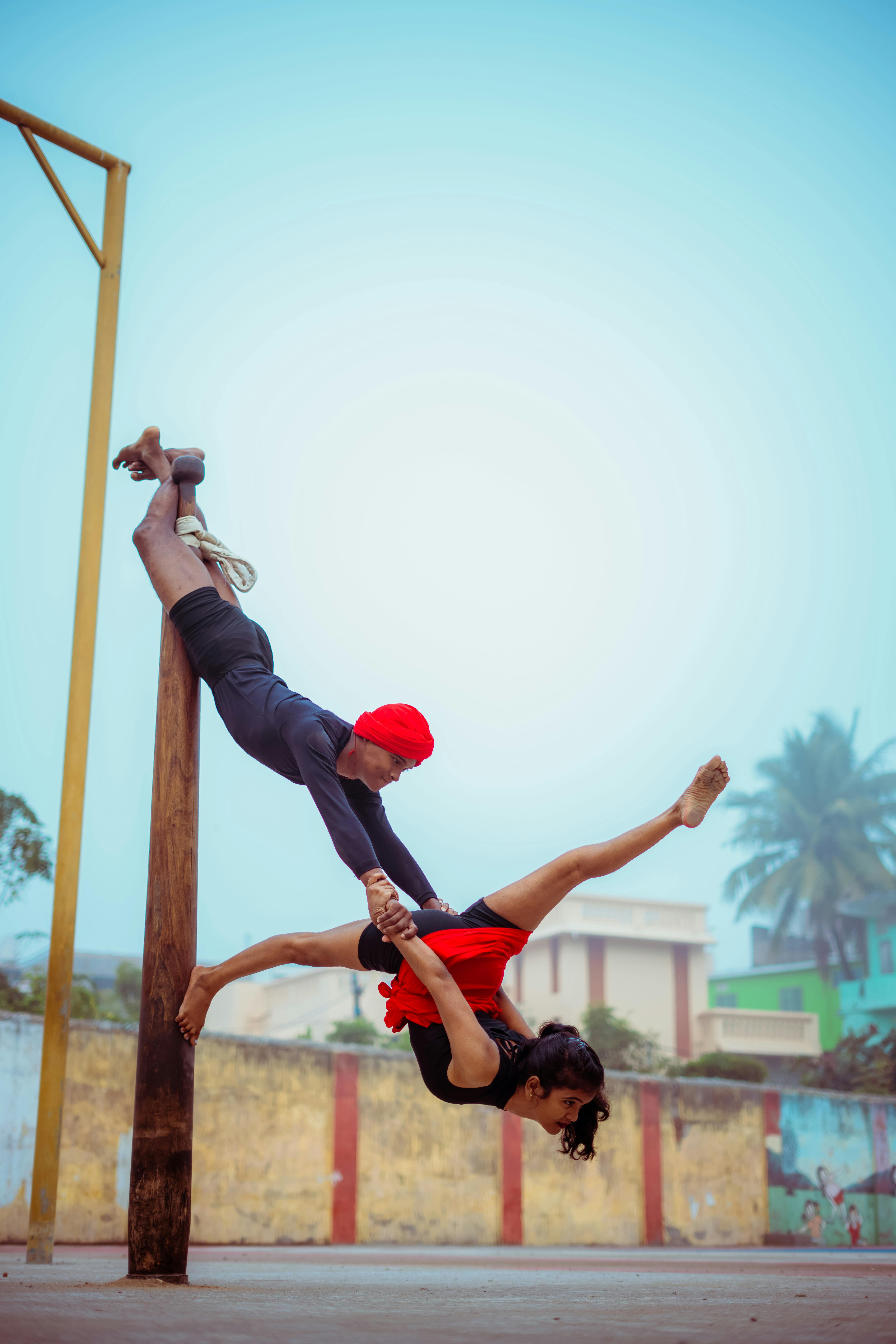 Acrobatic Mallakhamb Duo Performing Outdoors · Free Stock Photo