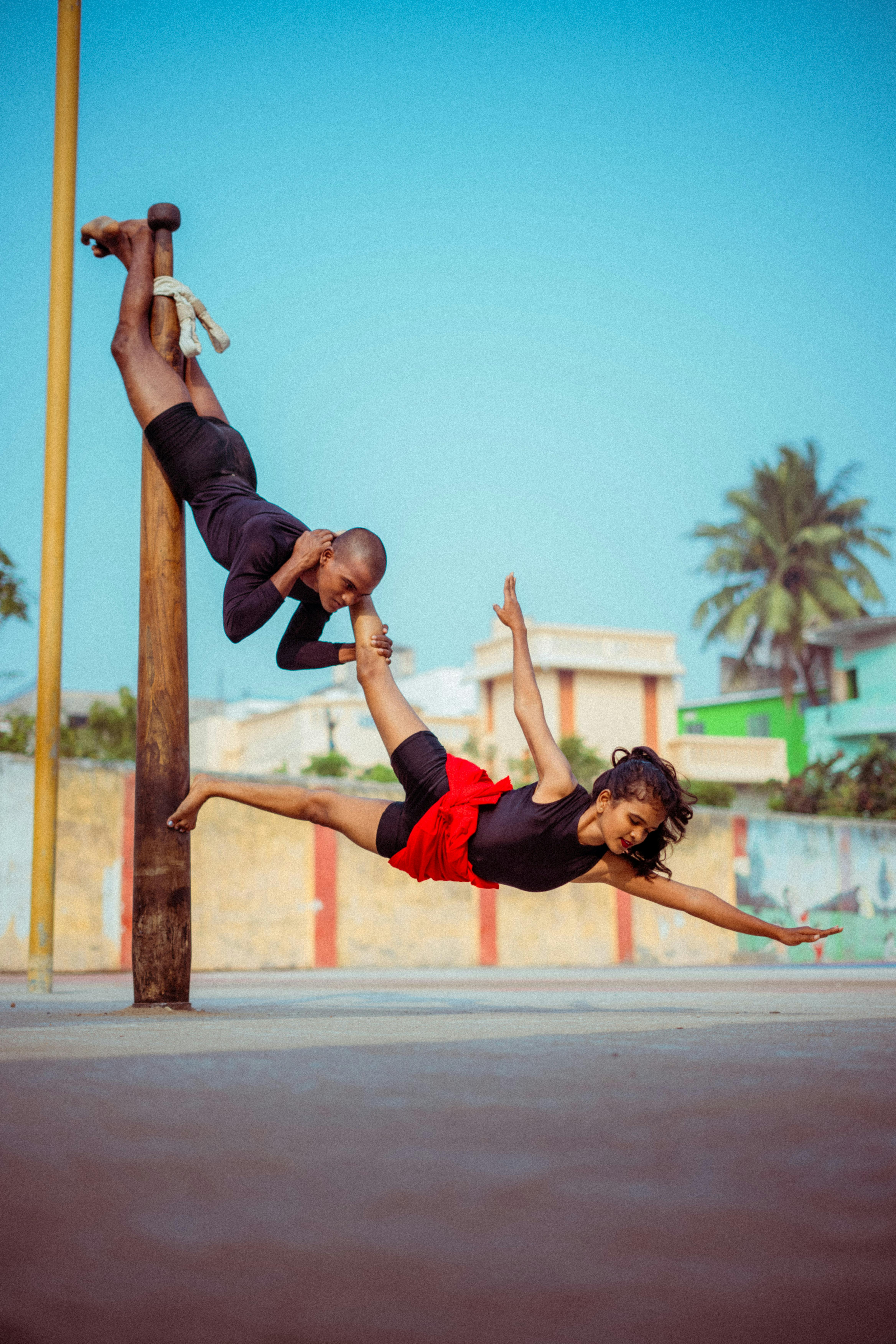 Dynamic Mallakhamb Duo Performing Outdoors · Free Stock Photo