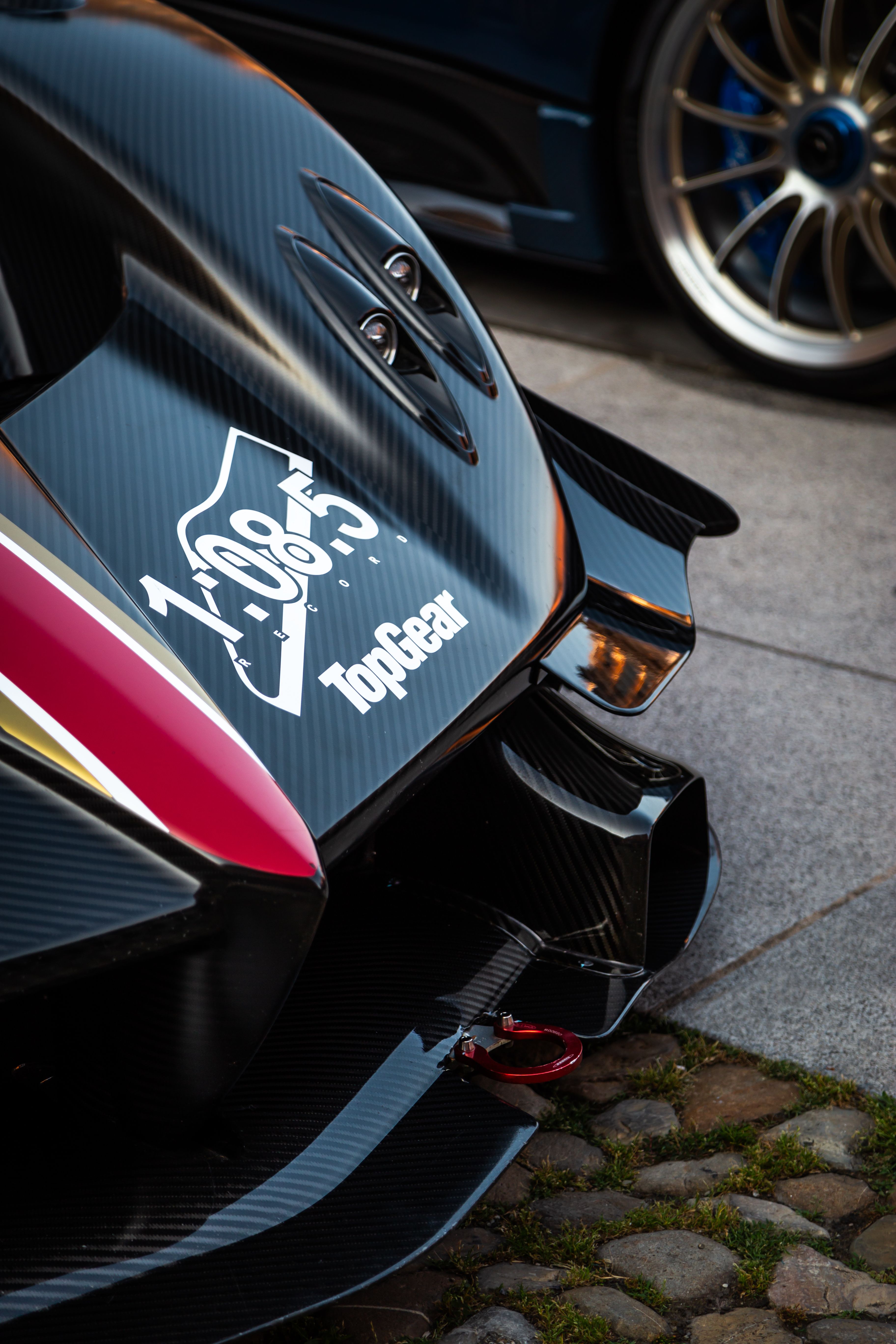 Dynamic Carbon Fiber Supercar Close-Up at Outdoor Exhibit · Free Stock ...