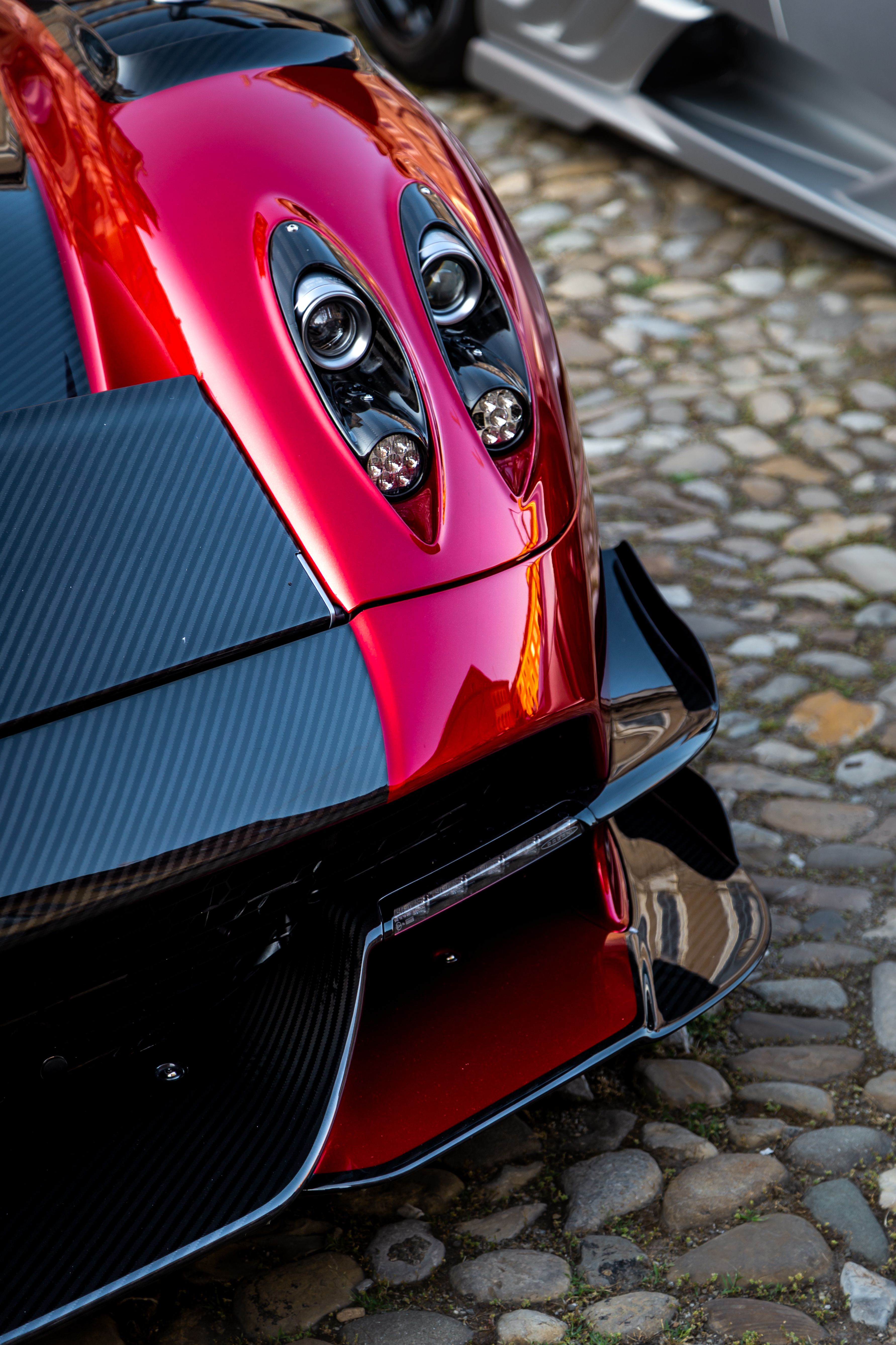 Close-Up of a Red Supercar on Cobblestone · Free Stock Photo