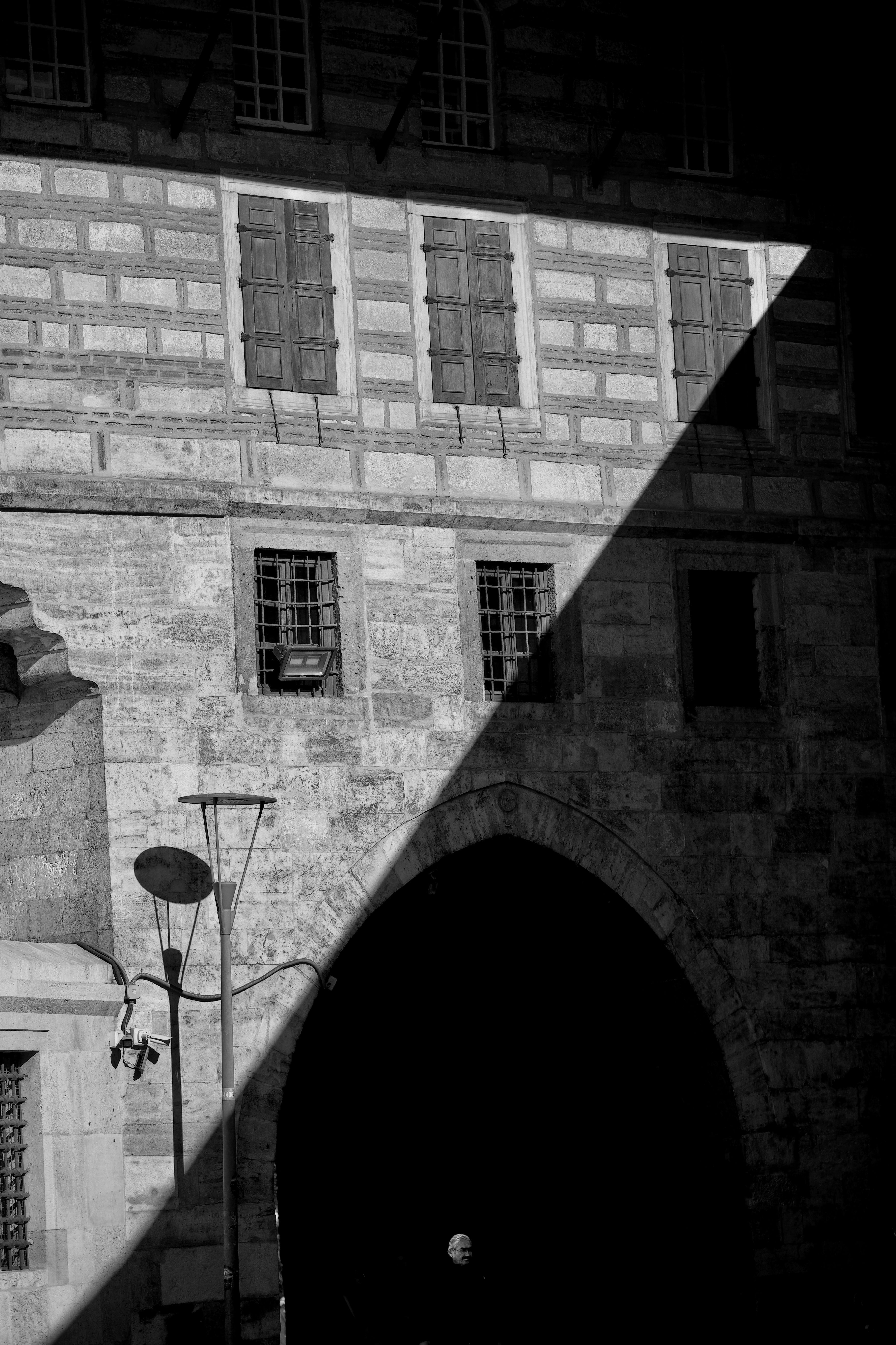 Historic Stone Building with Dramatic Shadows · Free Stock Photo