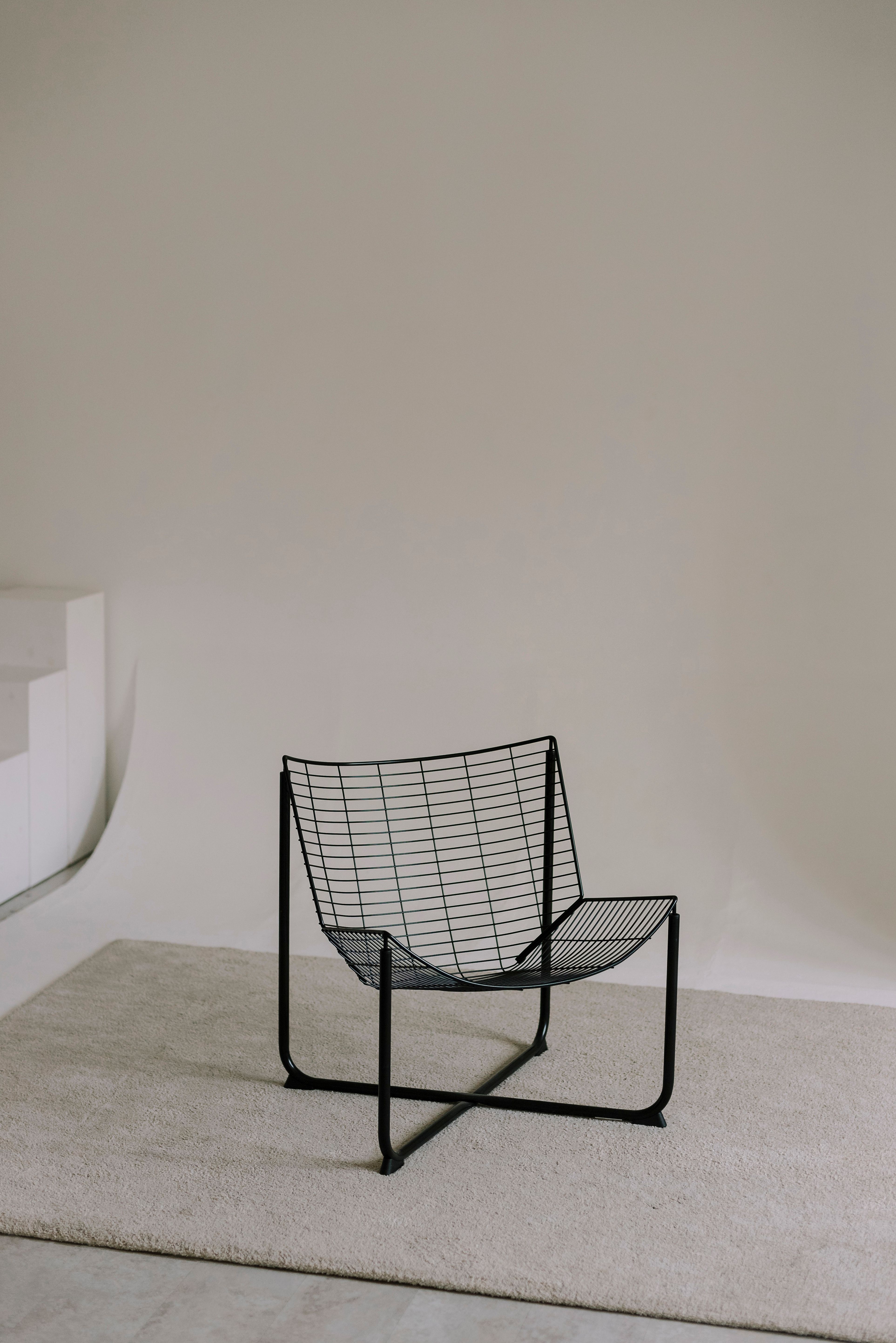 Minimalist Wire Chair on Beige Carpet · Free Stock Photo