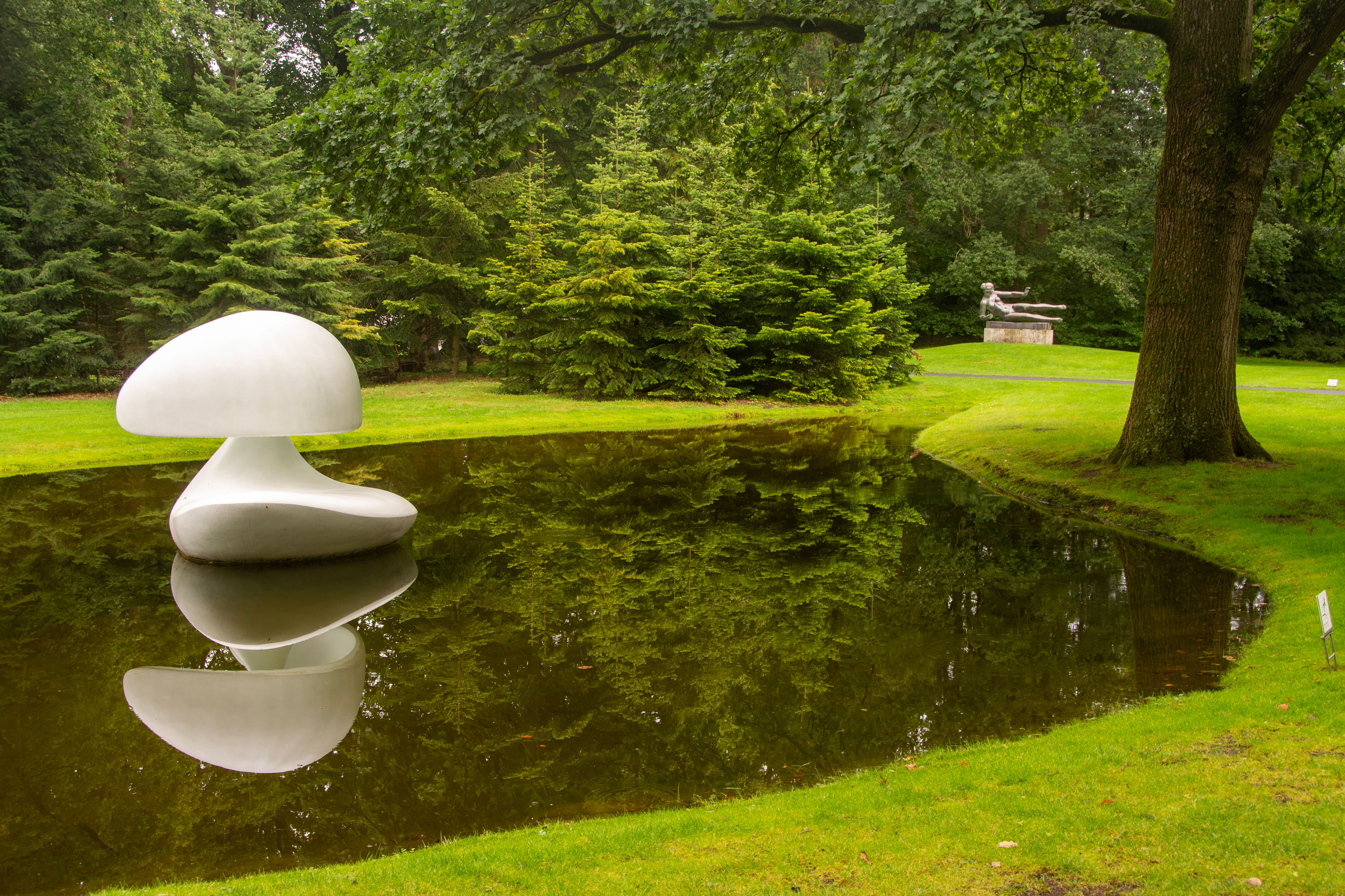 Serene Park Pond with Abstract Sculpture Reflection · Free Stock Photo