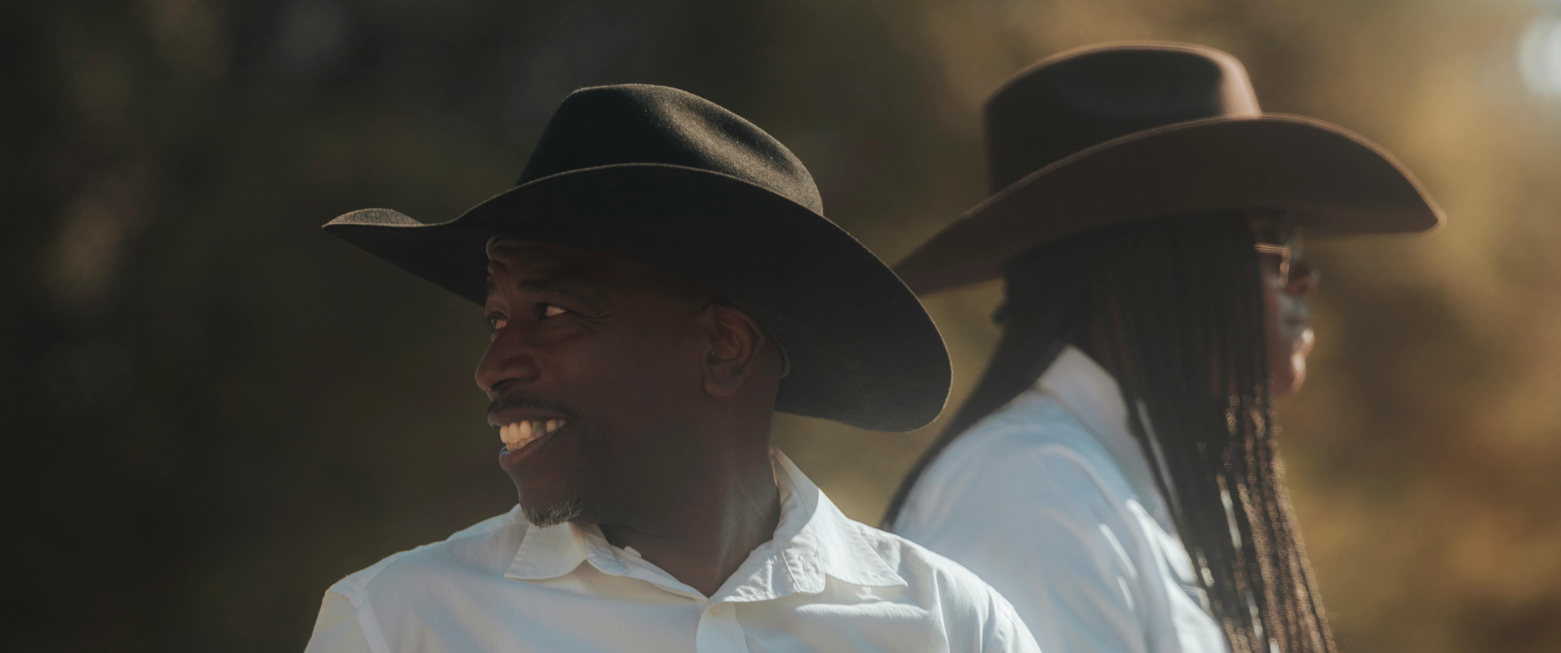 Portrait of Smiling Cowboys in Sunlit Scene · Free Stock Photo