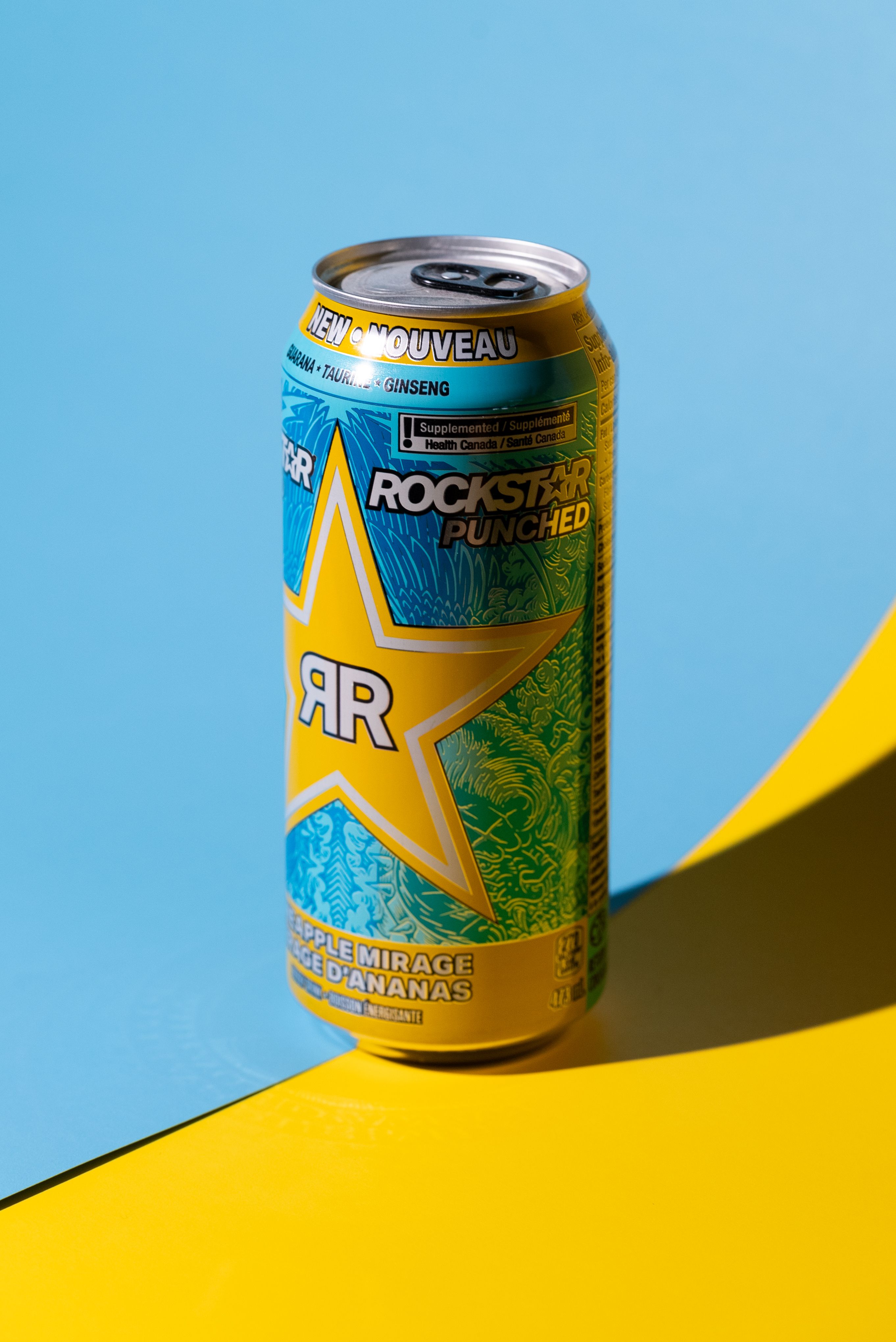 Vibrant Rockstar Energy Drink Can on Colorful Background · Free Stock Photo