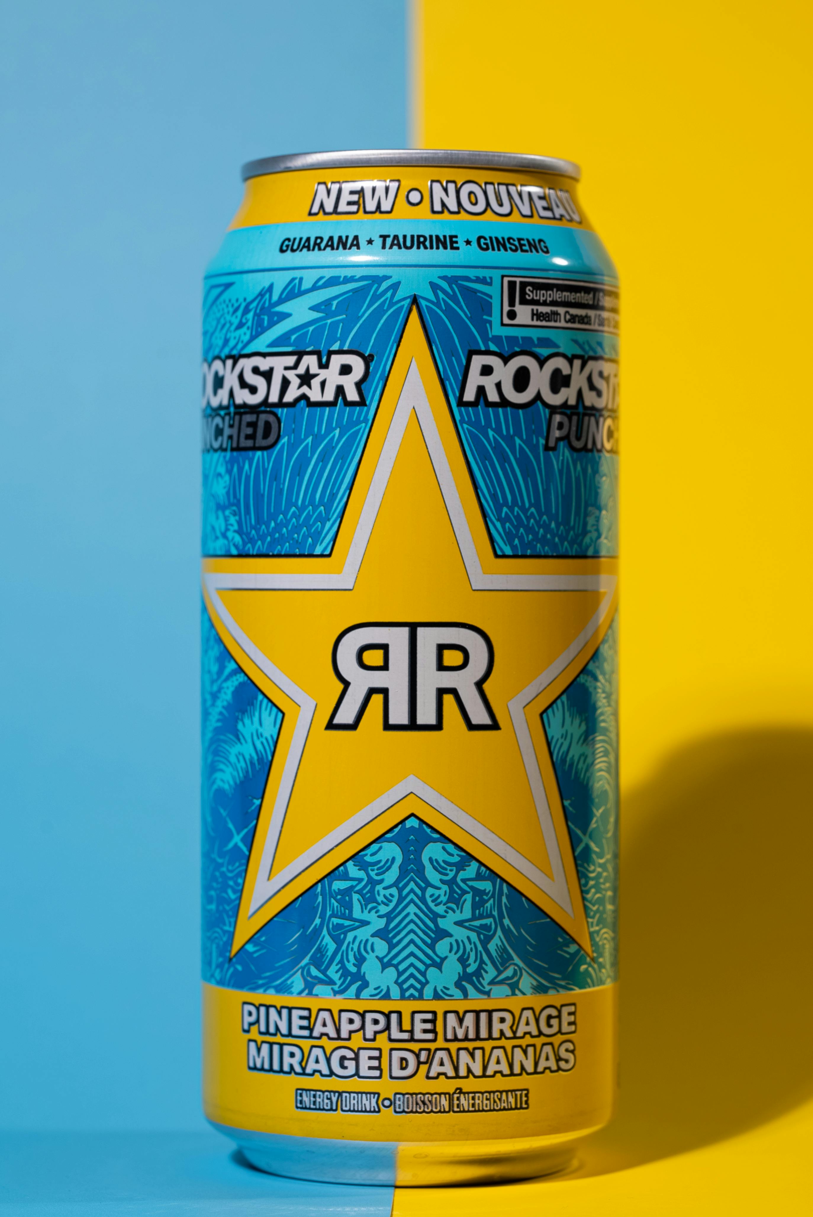 Vibrant Rockstar Energy Drink Can on Dual Background · Free Stock Photo