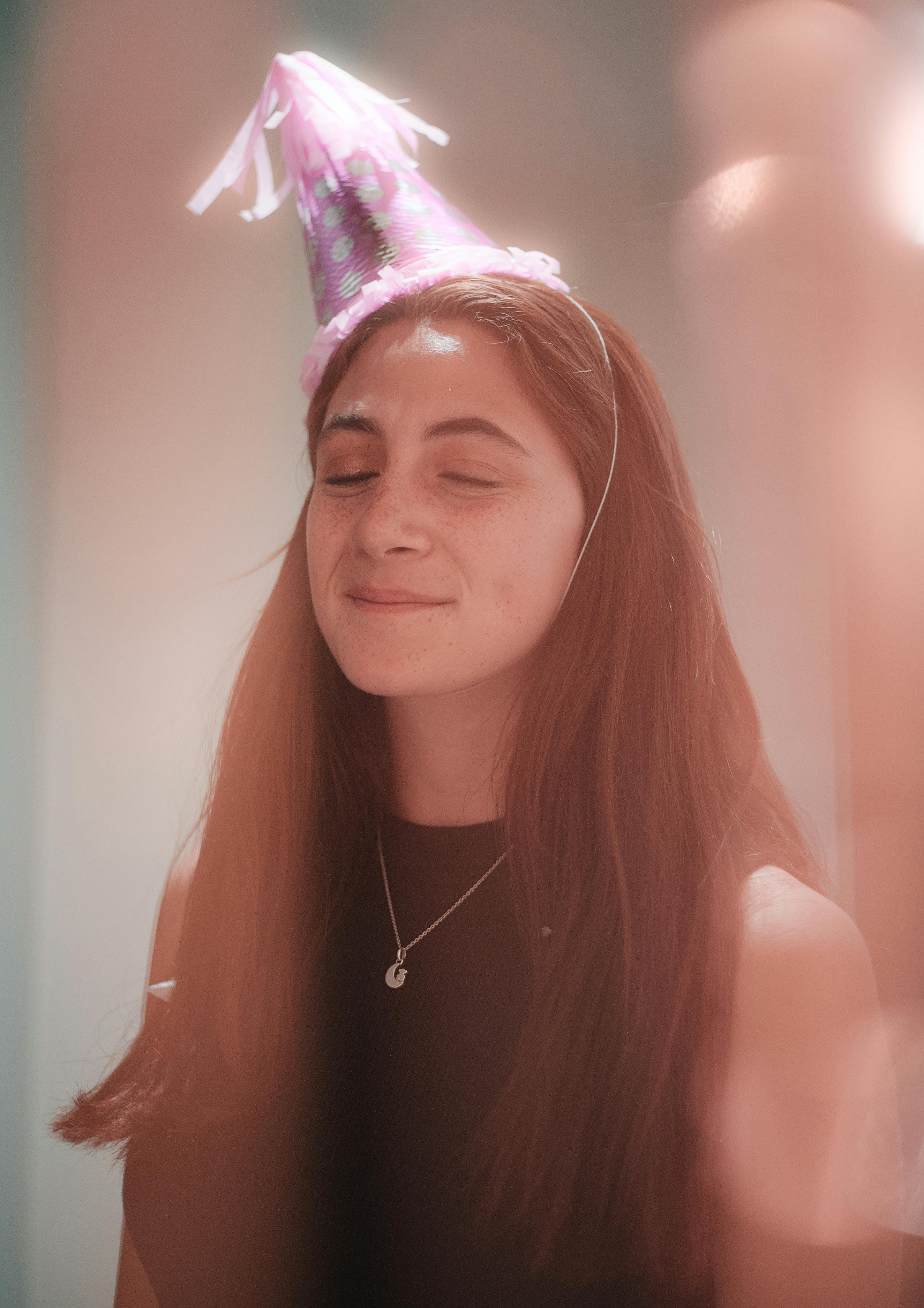 Young Woman Celebrating with Party Hat · Free Stock Photo
