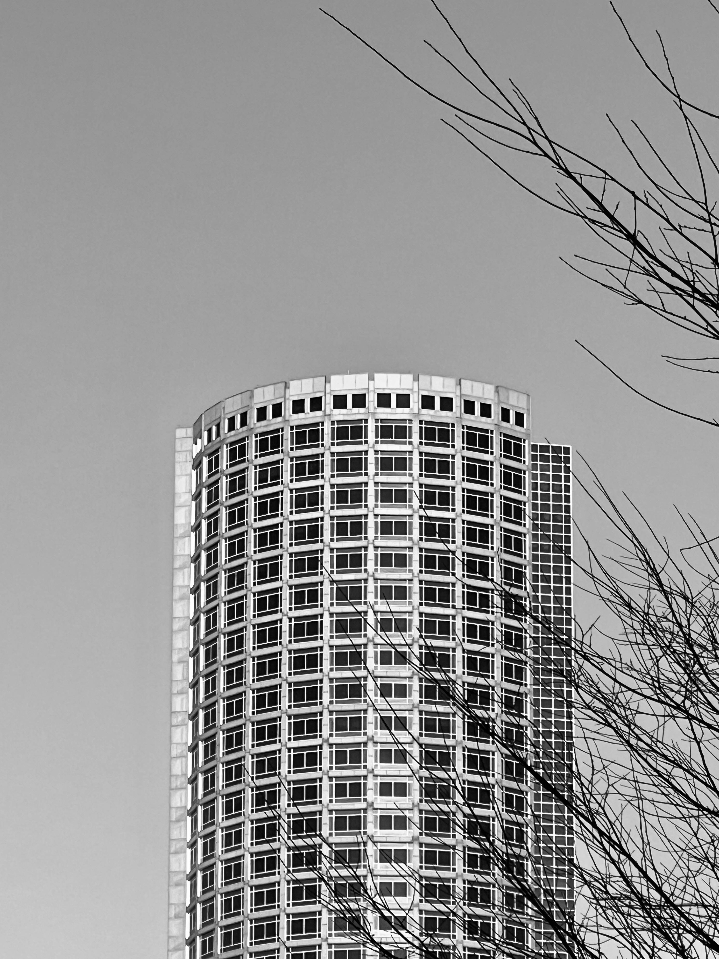 Modern high-rise building with geometric facade · Free Stock Photo