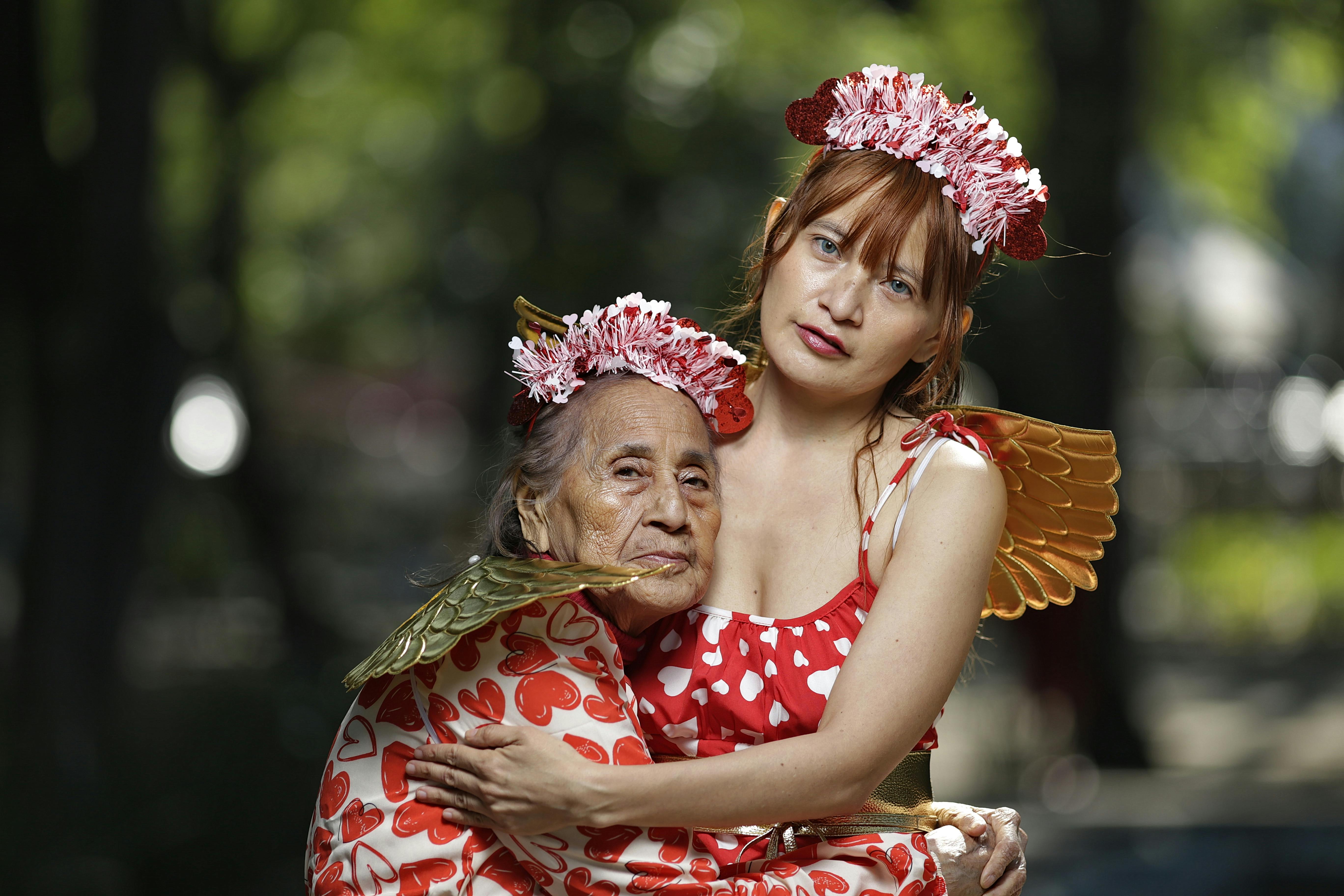 Mother and Daughter Embracing in Cupid Costumes Outdoors · Free Stock Photo