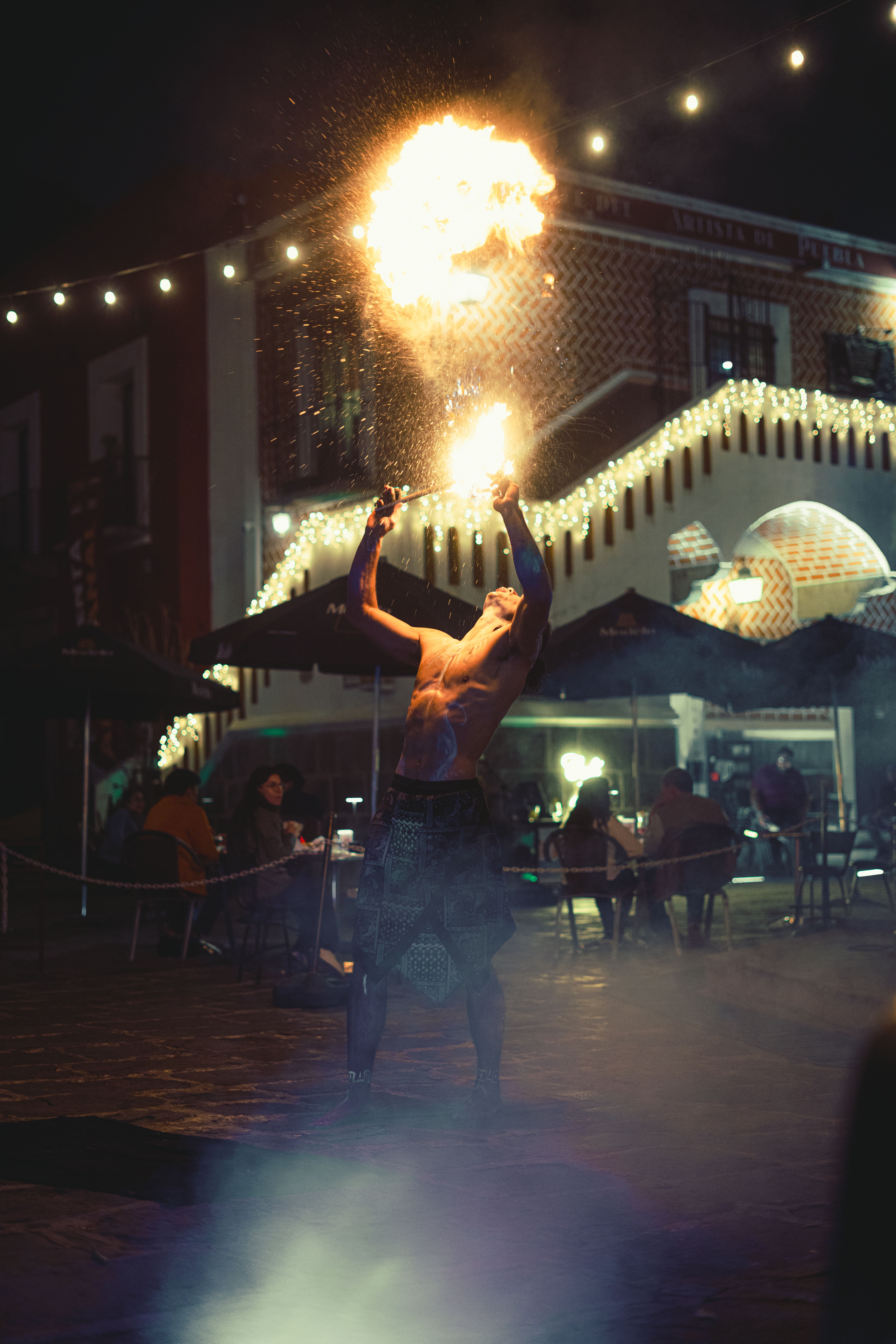 Nighttime Fire Performer in a Vibrant City Setting · Free Stock Photo