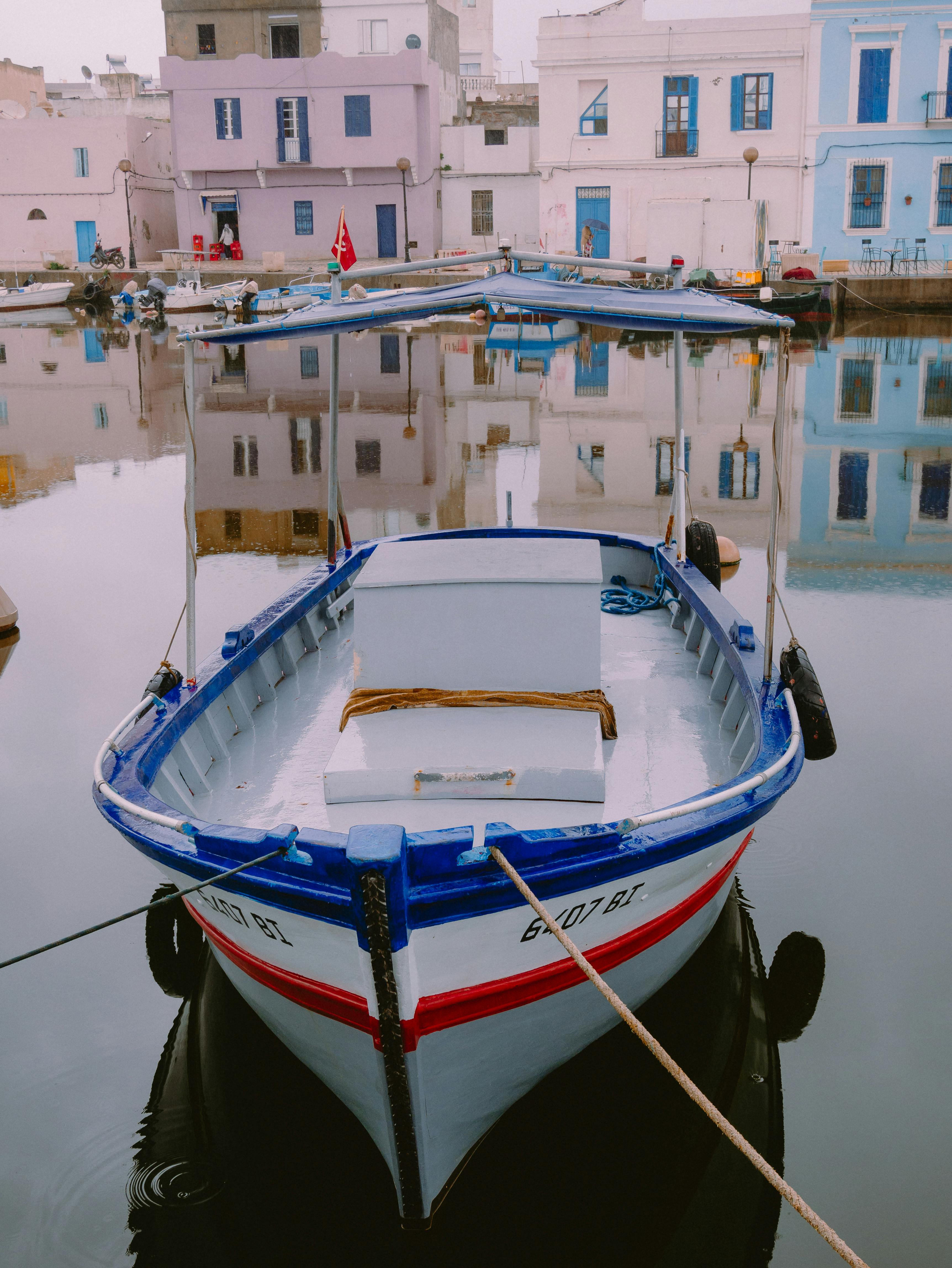 Charming Fishing Boat in Quaint Waterfront Town · Free Stock Photo