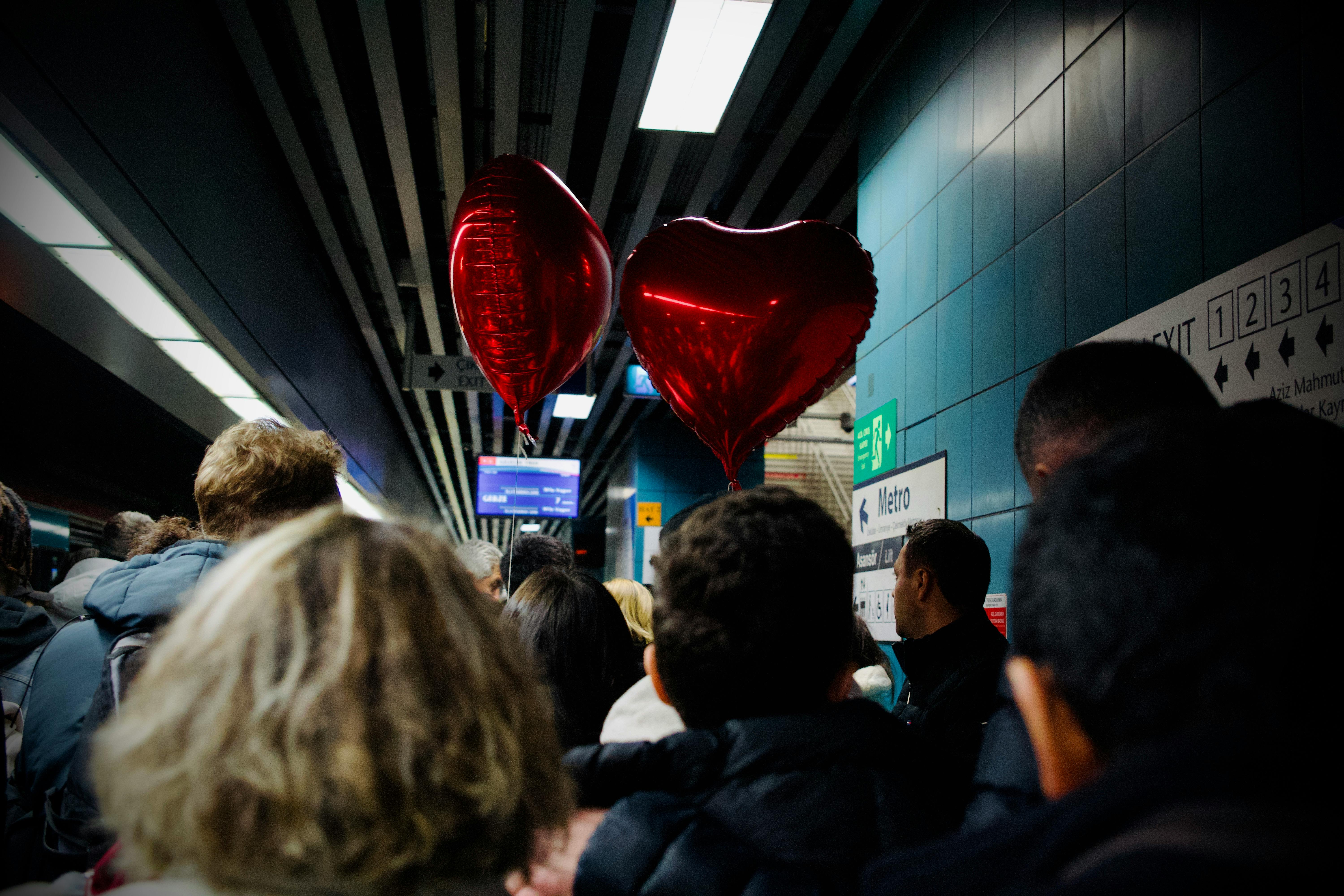 Crowd at Subway with Heart-shaped Balloons · Free Stock Photo