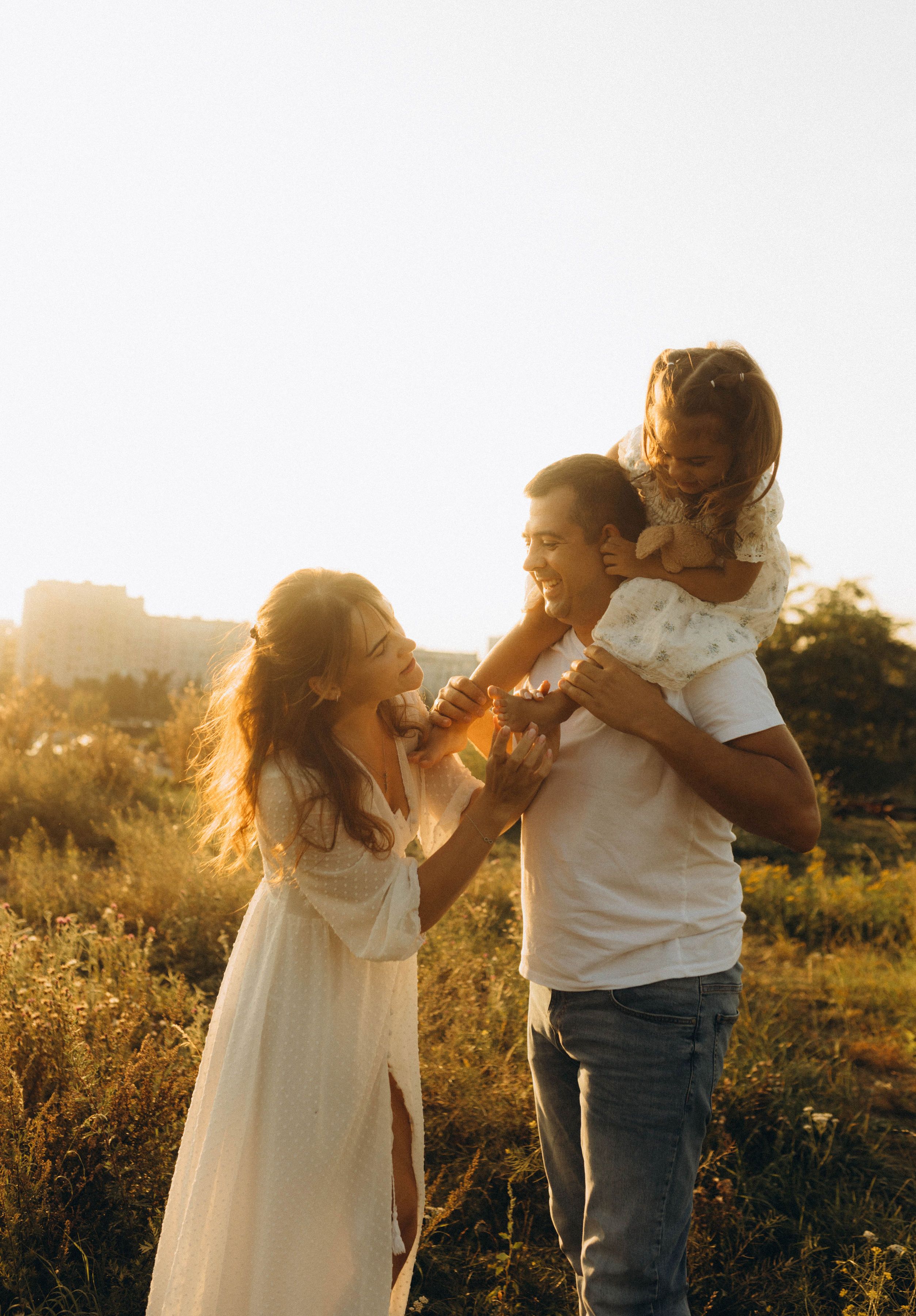 Happy Family Bonding Outdoors at Sunset · Free Stock Photo