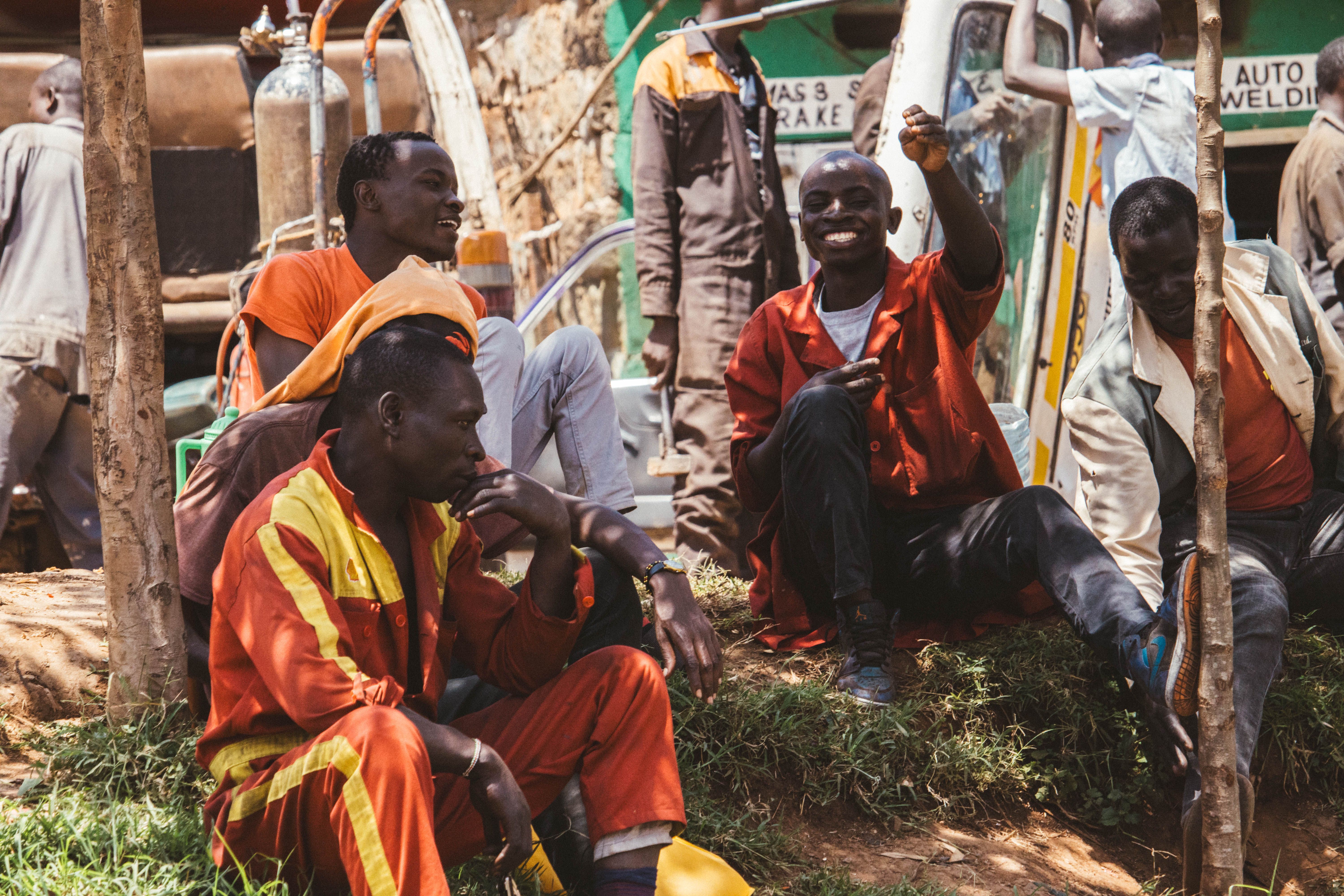 Mechanics Relaxing Outdoors in Nairobi Garage · Free Stock Photo