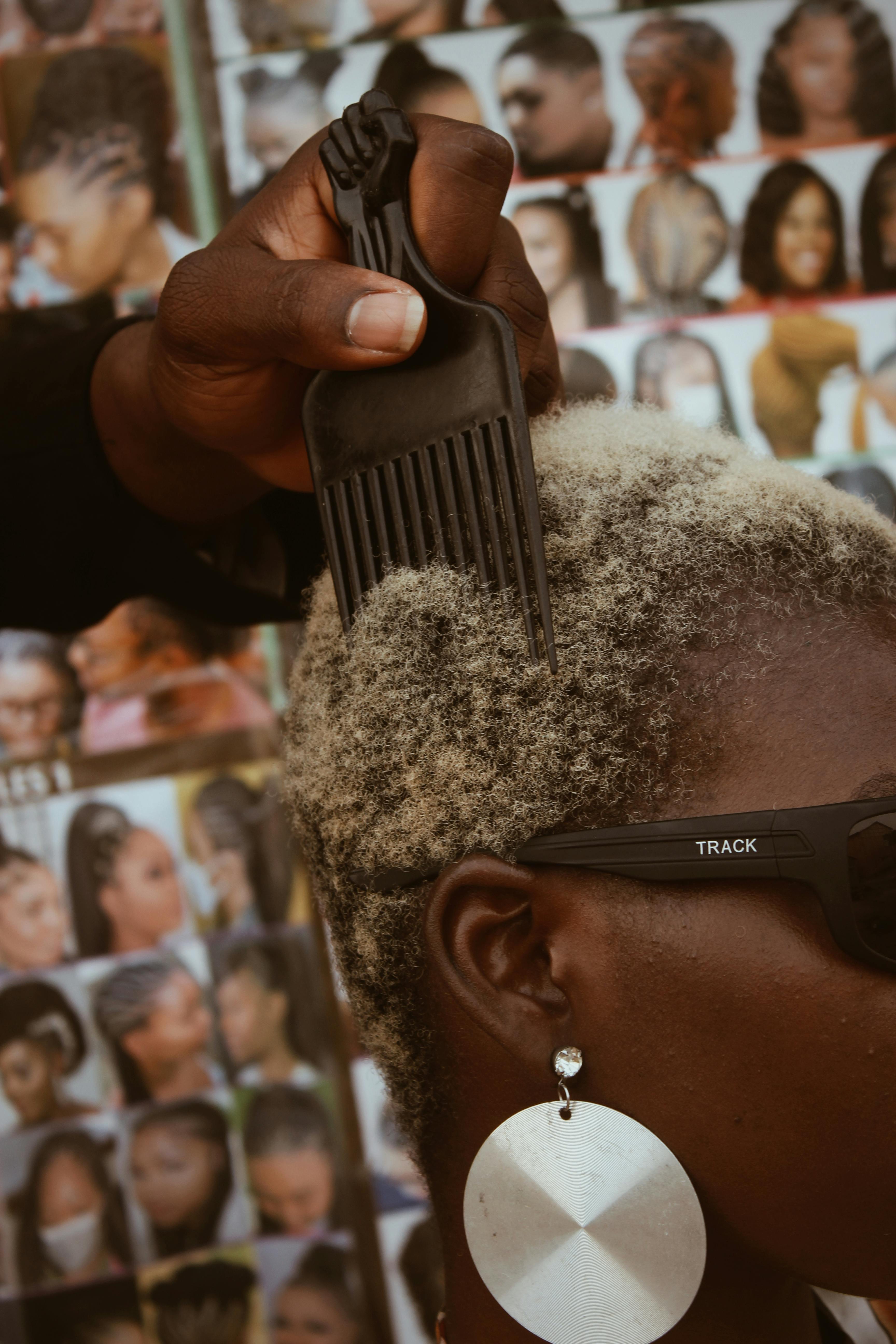 Close-up of Styling Afro Hair with Comb · Free Stock Photo