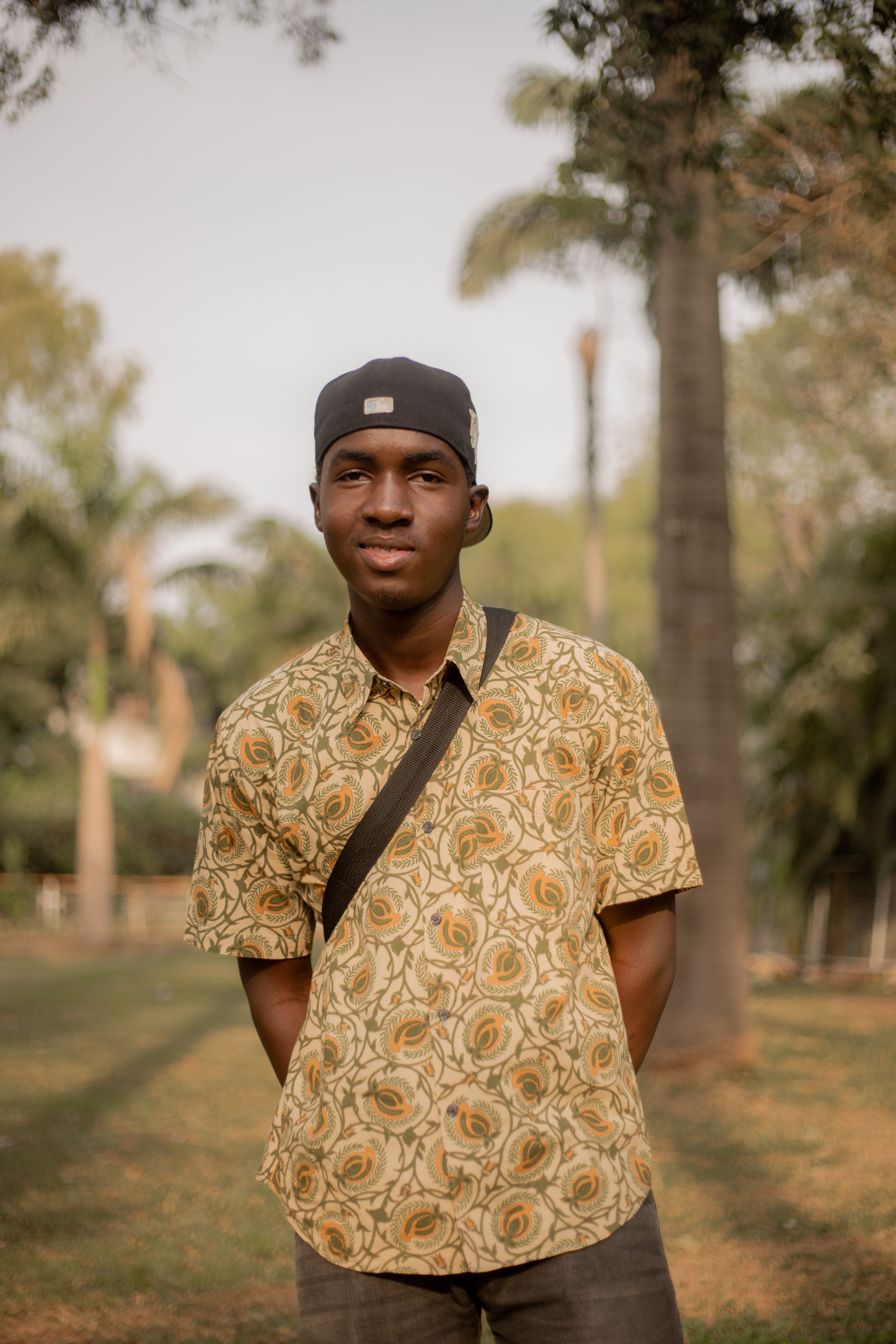 Young Man in Patterned Shirt in Abuja Park · Free Stock Photo