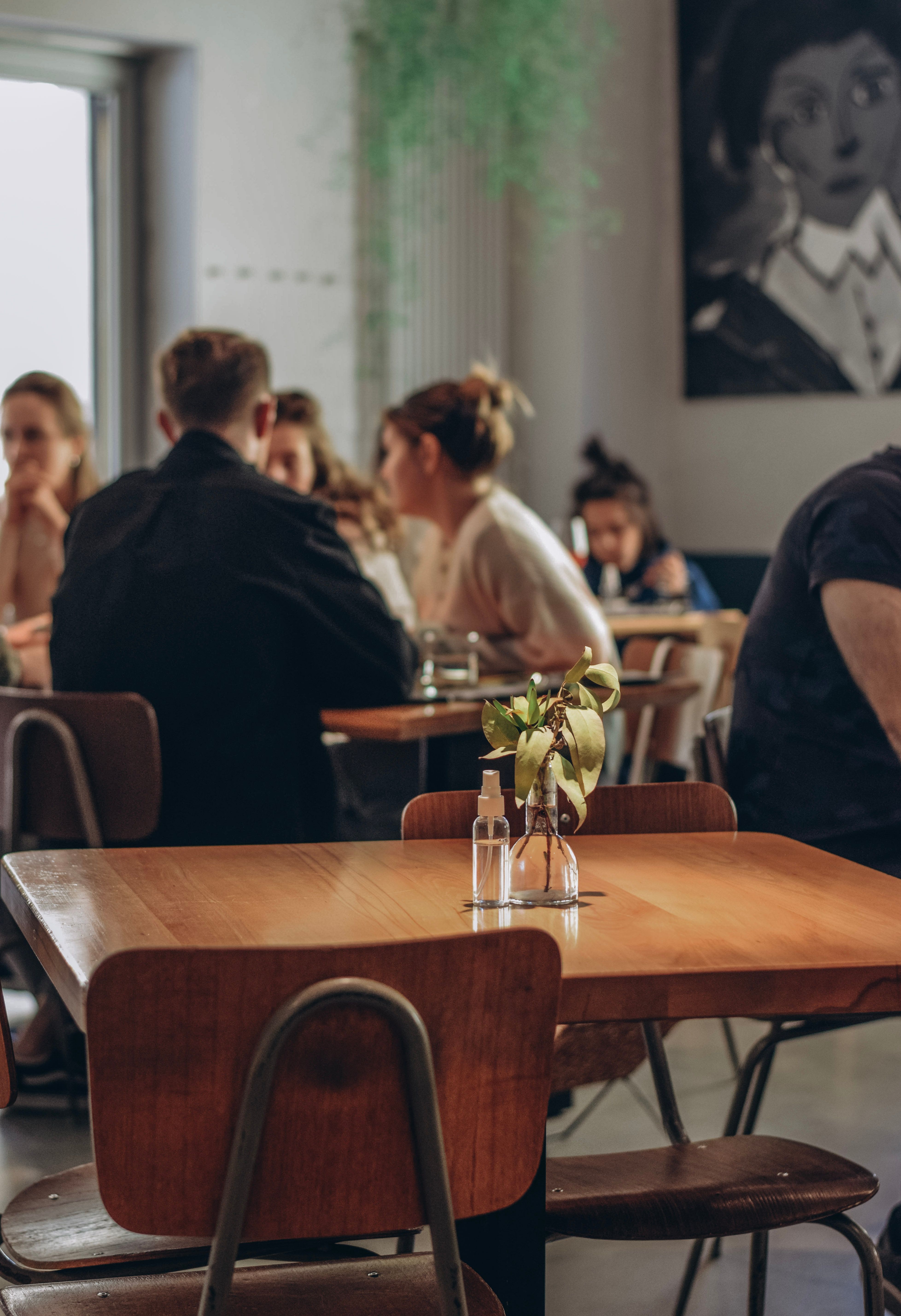 People Inside a Cafe With Tables and Chairs · Free Stock Photo