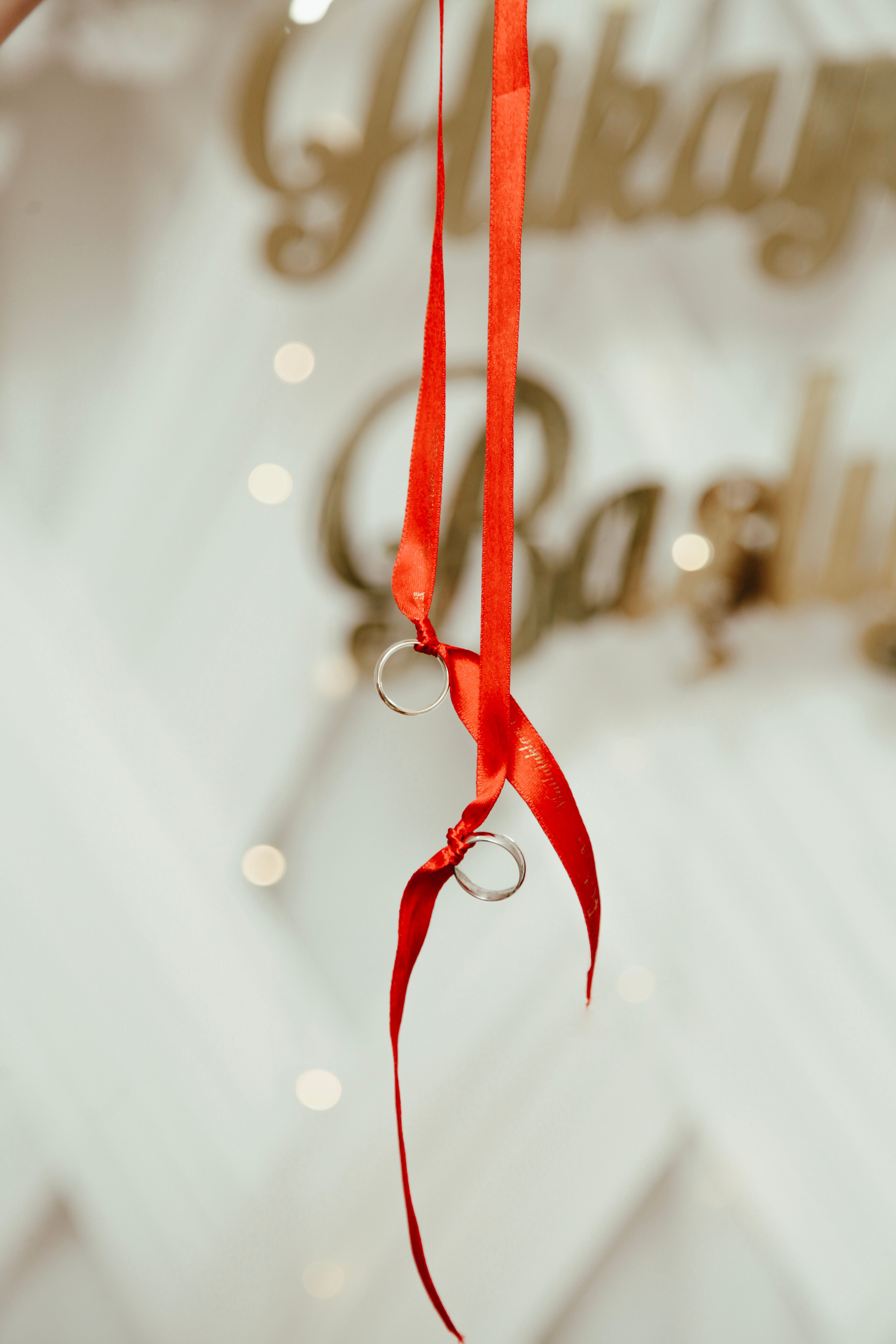 Elegant Wedding Rings with Red Ribbon Decoration · Free Stock Photo