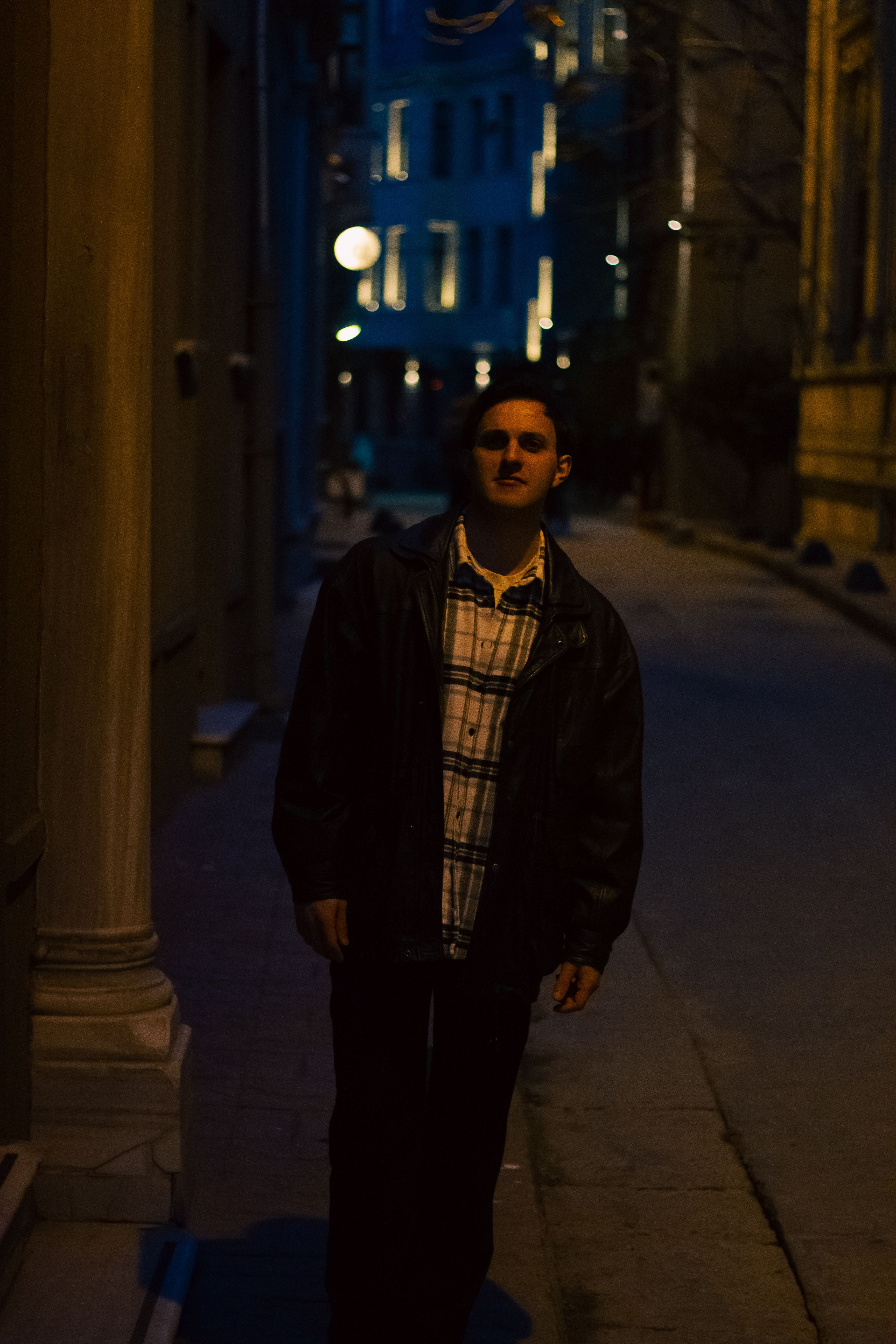 Young Man Walking Alone at Night in Urban Street · Free Stock Photo
