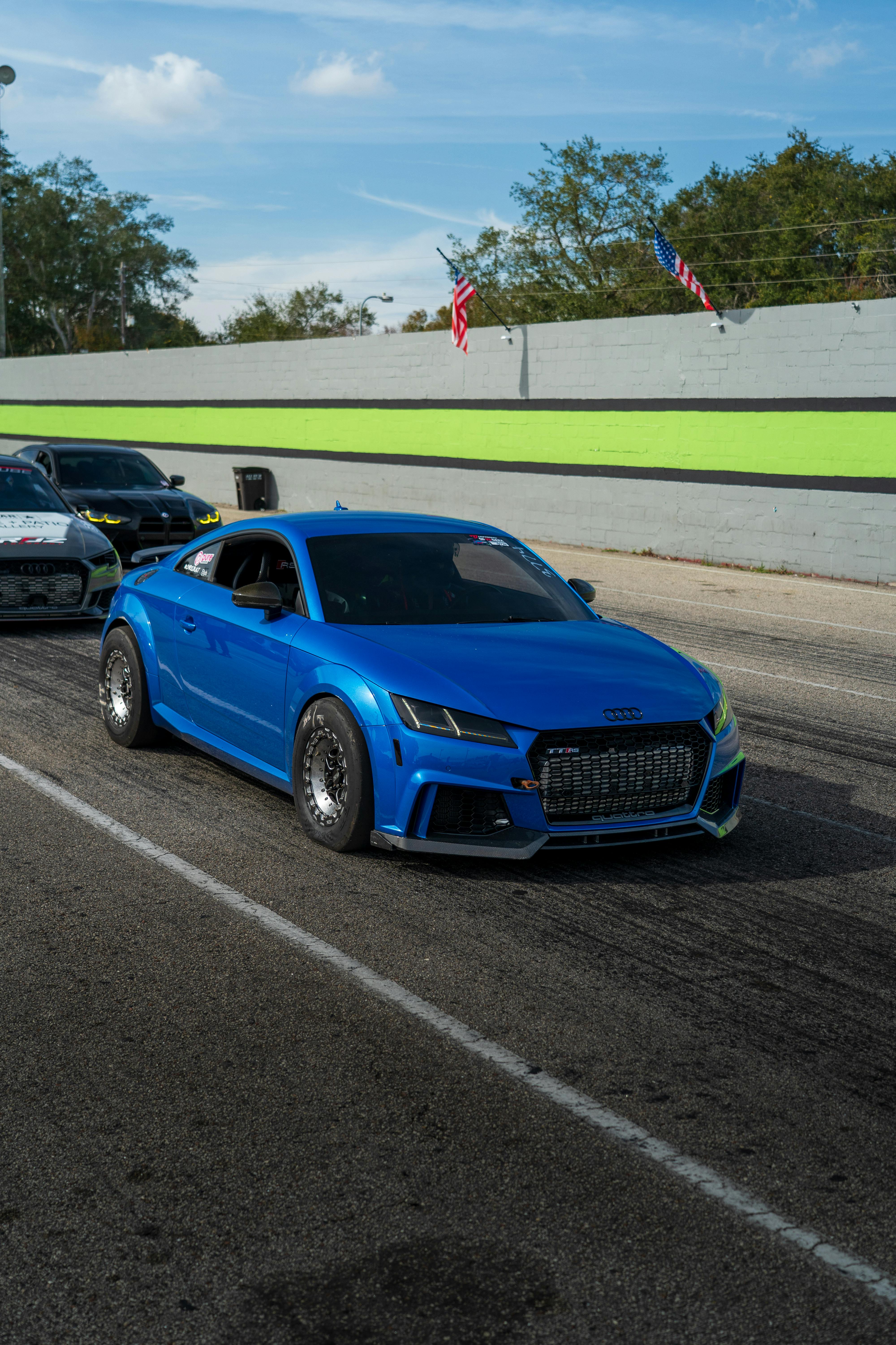 Blue Sports Car on Racetrack Outdoors · Free Stock Photo