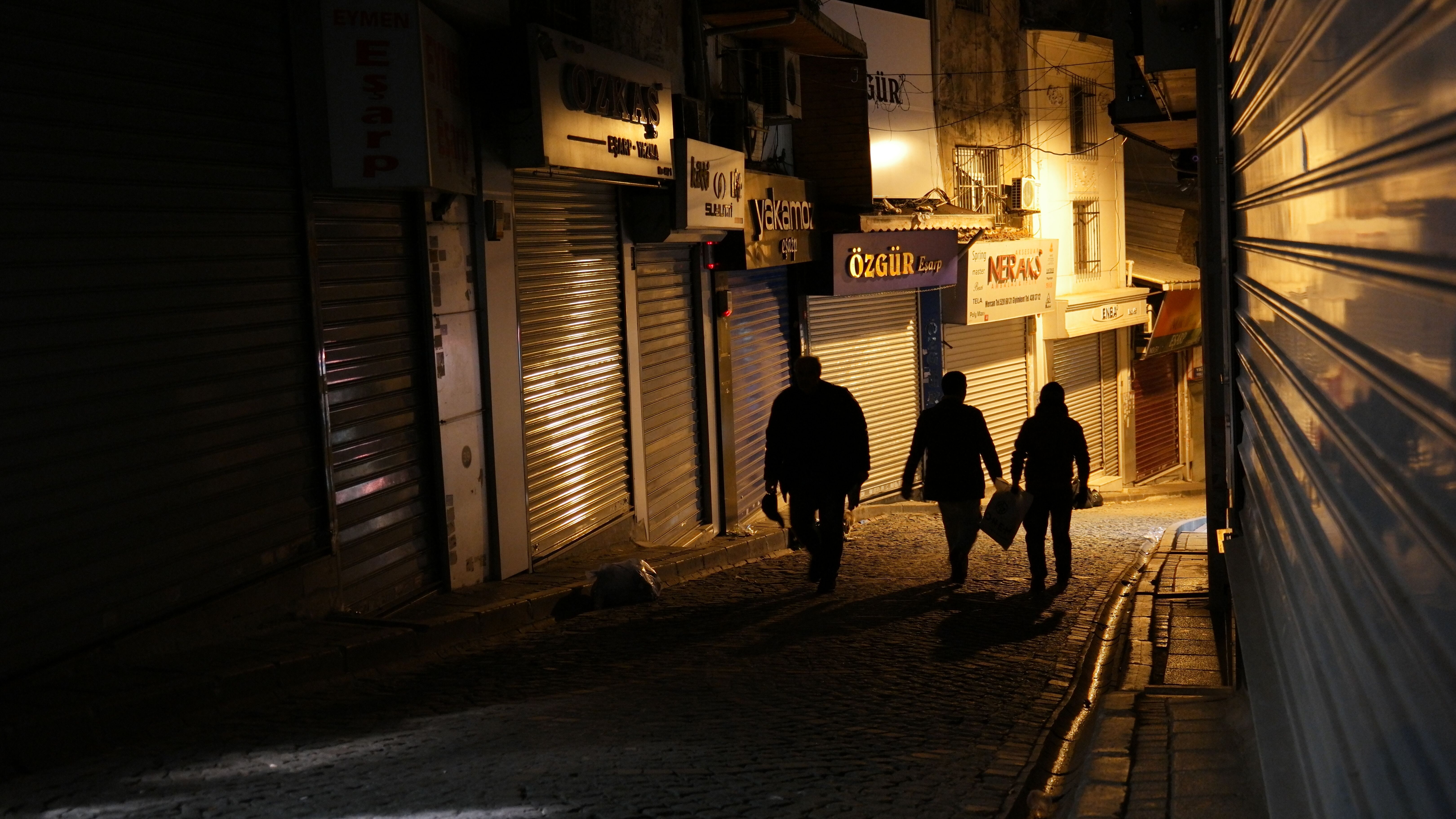 Silhouetted Figures Walking on Quiet Night Street · Free Stock Photo