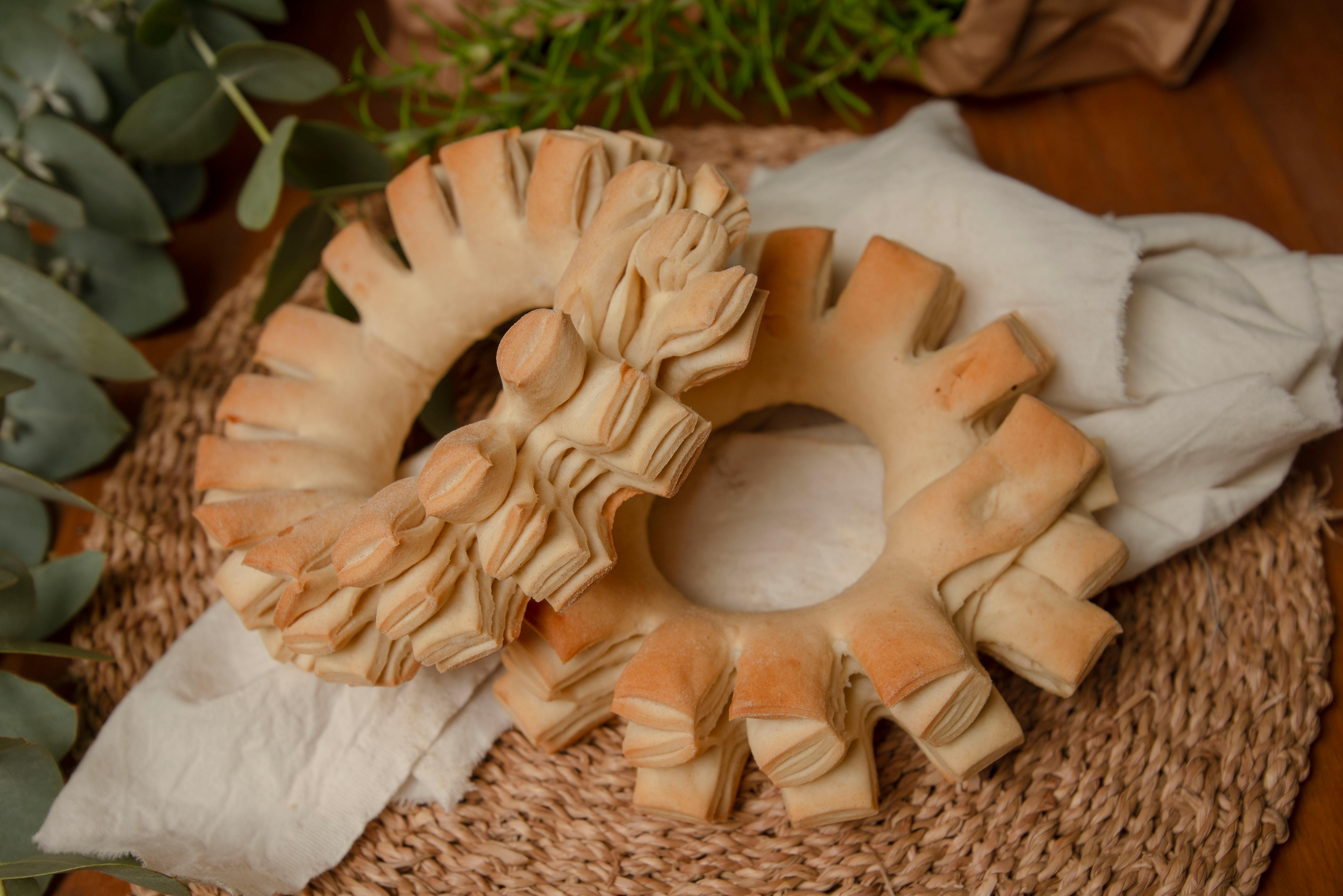 Rustic Round Bread with Textured Crust on Cloth · Free Stock Photo
