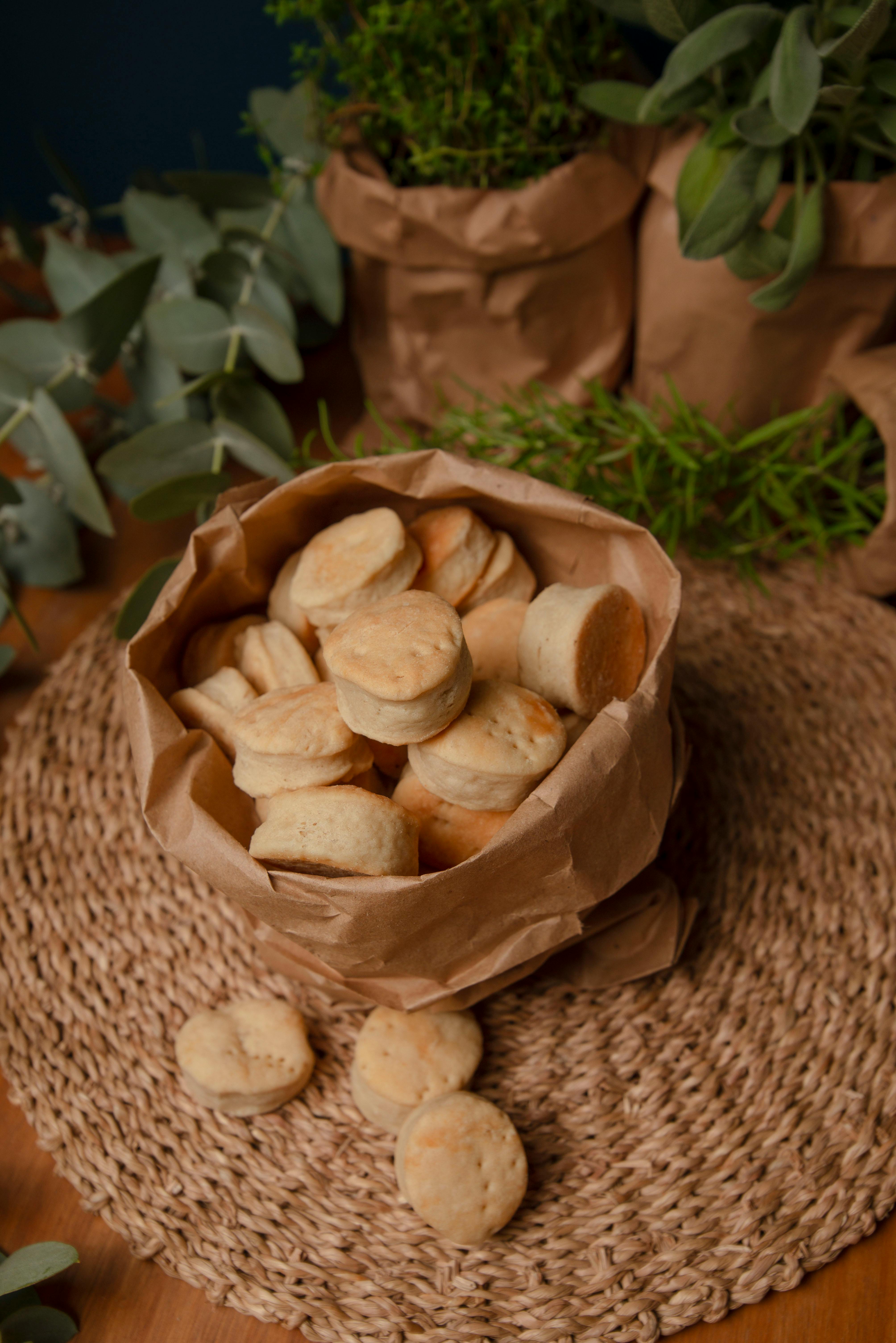 Rustic Biscuits in Paper Bag Surrounded by Greenery · Free Stock Photo