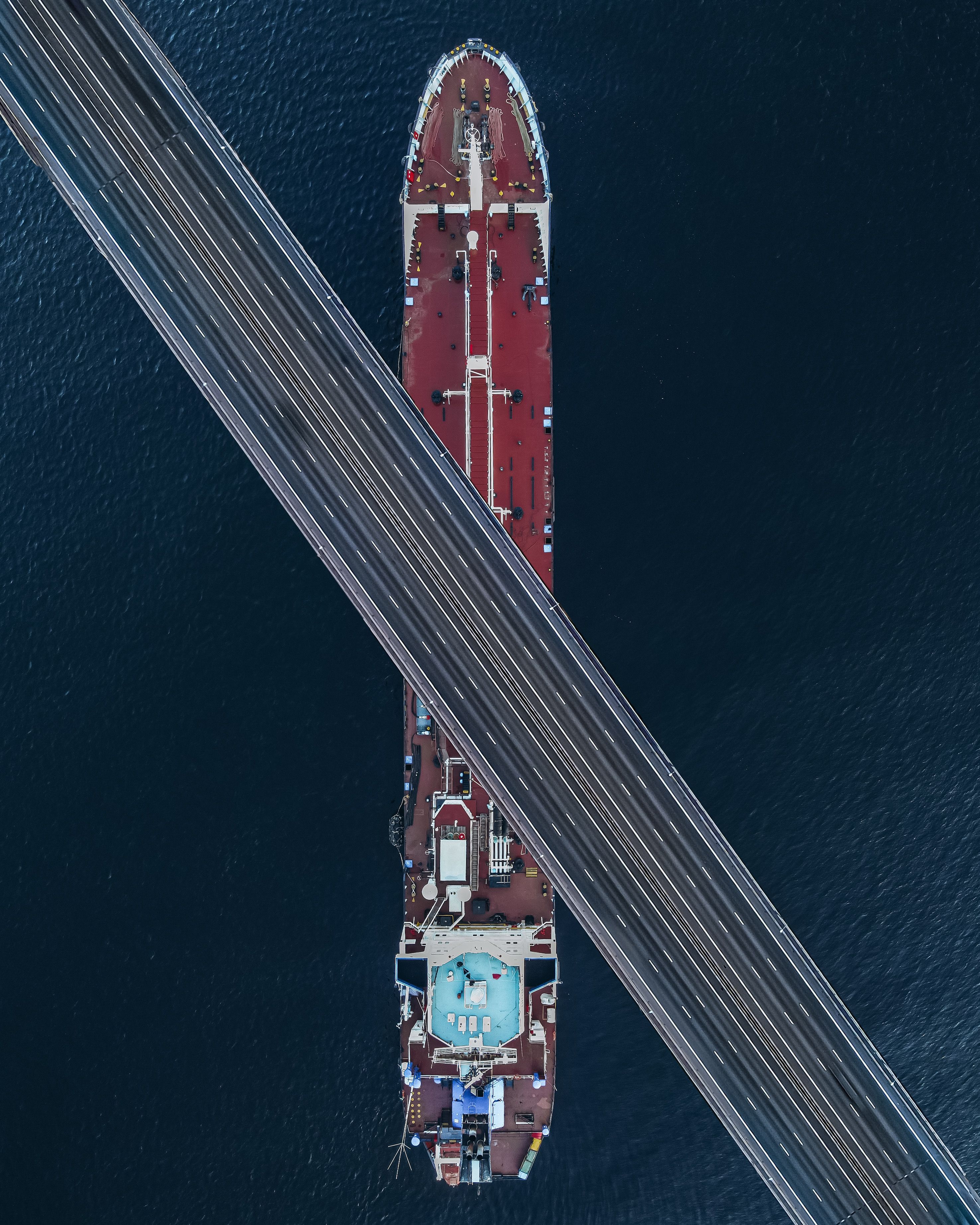 Aerial View of Bridge Over Ship in Coastal Waters · Free Stock Photo