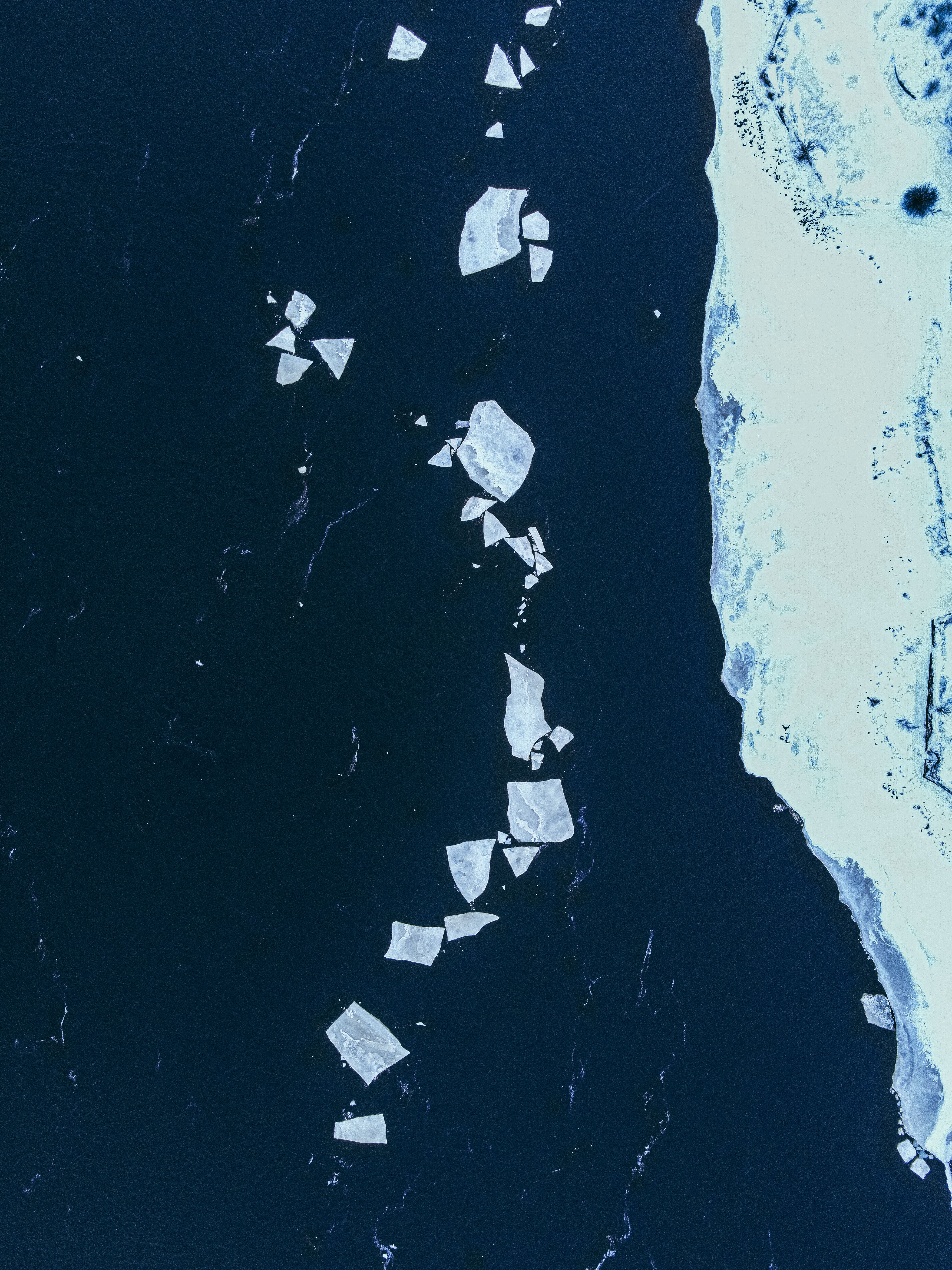 Aerial View of Ice Floes in Dark Icy Water · Free Stock Photo