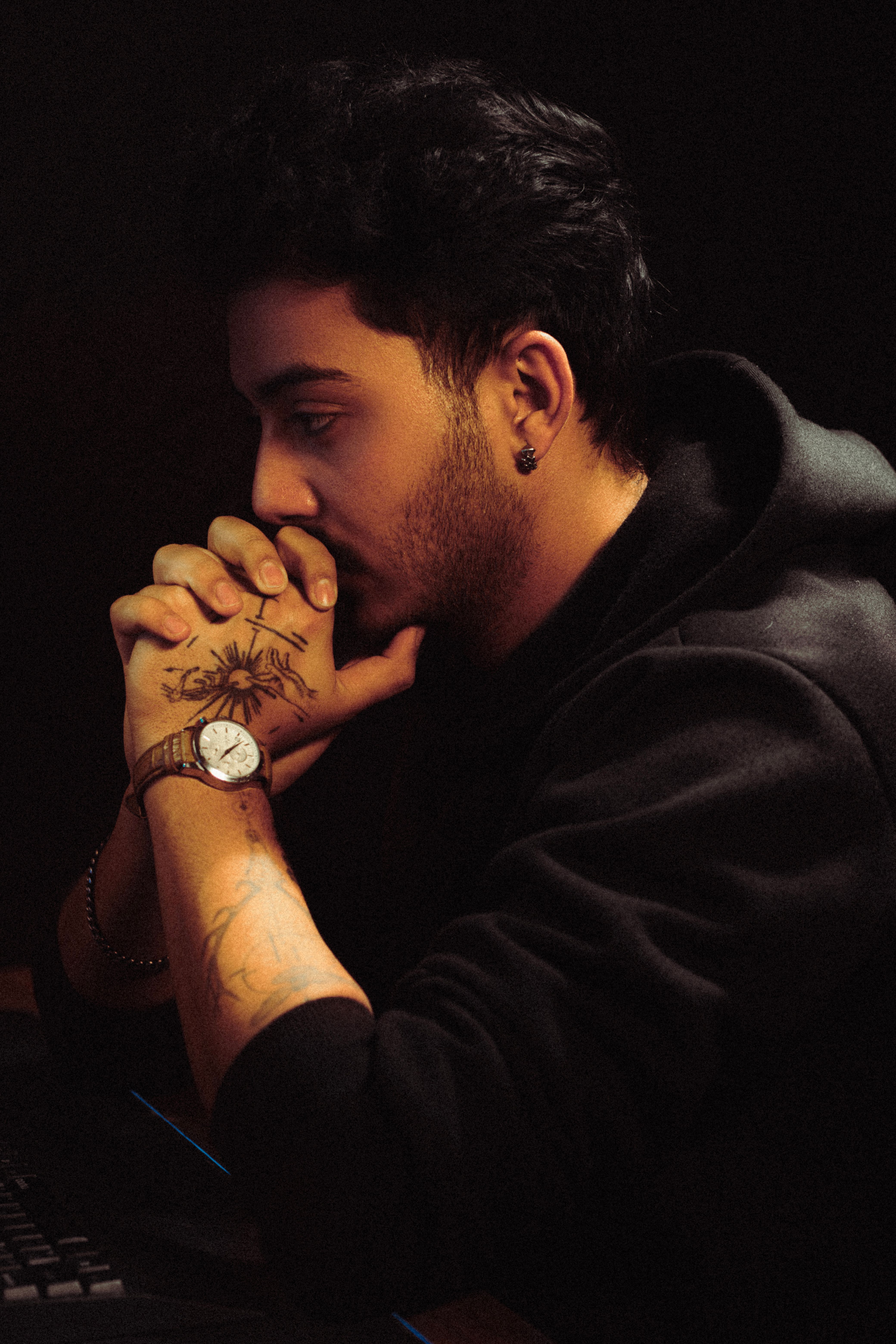 Pensive Man with Tattoos Deep in Thought · Free Stock Photo
