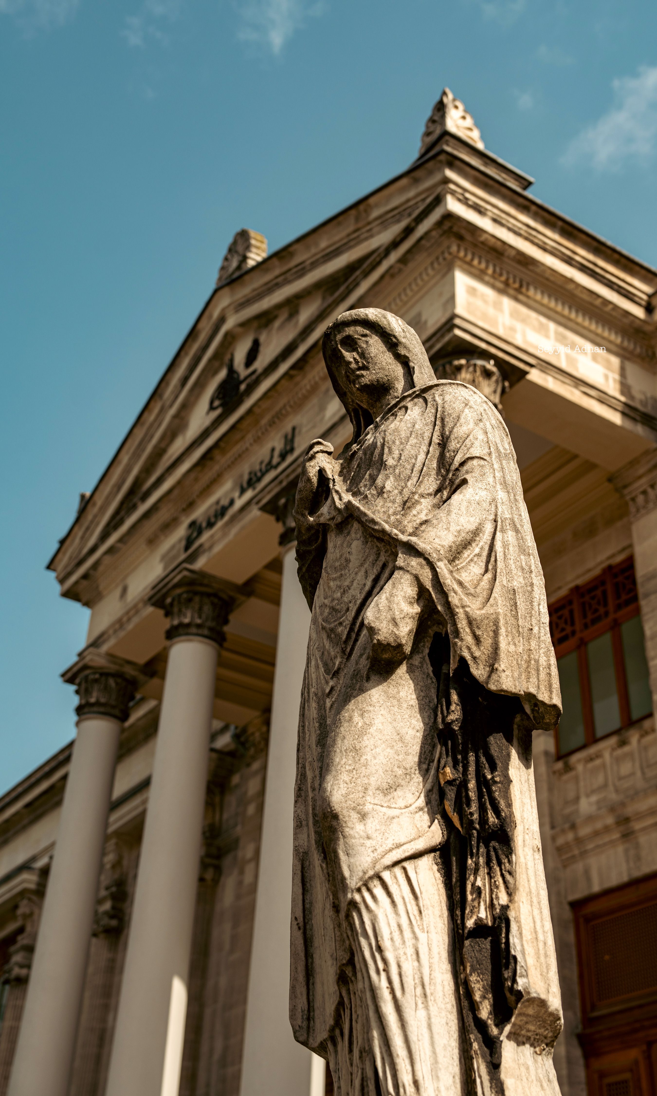 Historic Stone Statue in Front of Classical Building · Free Stock Photo
