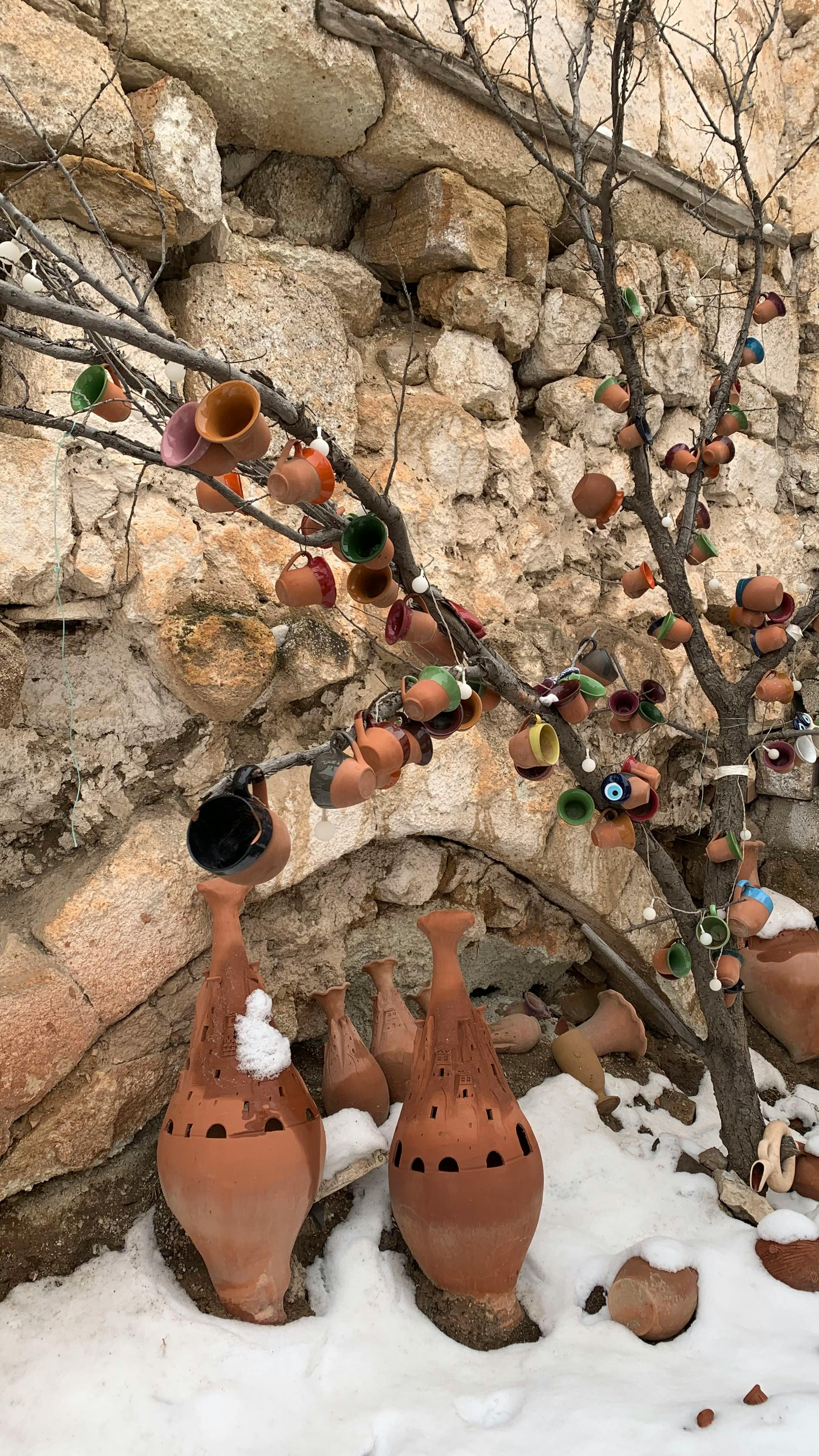 Rustic Winter Scene with Hanging Pots in Snow · Free Stock Photo