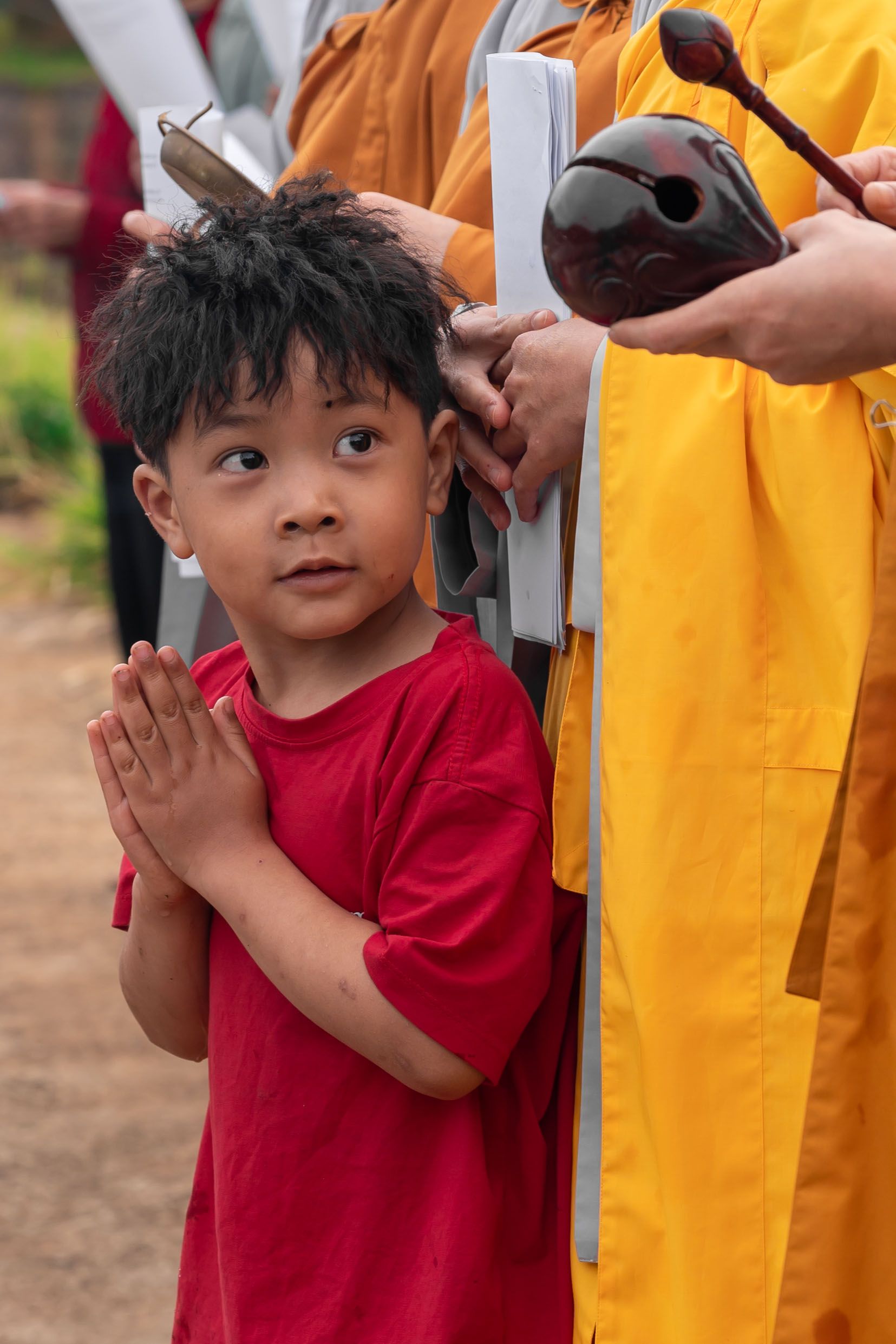 Child in Red Shirt Observing Monk Ceremony · Free Stock Photo
