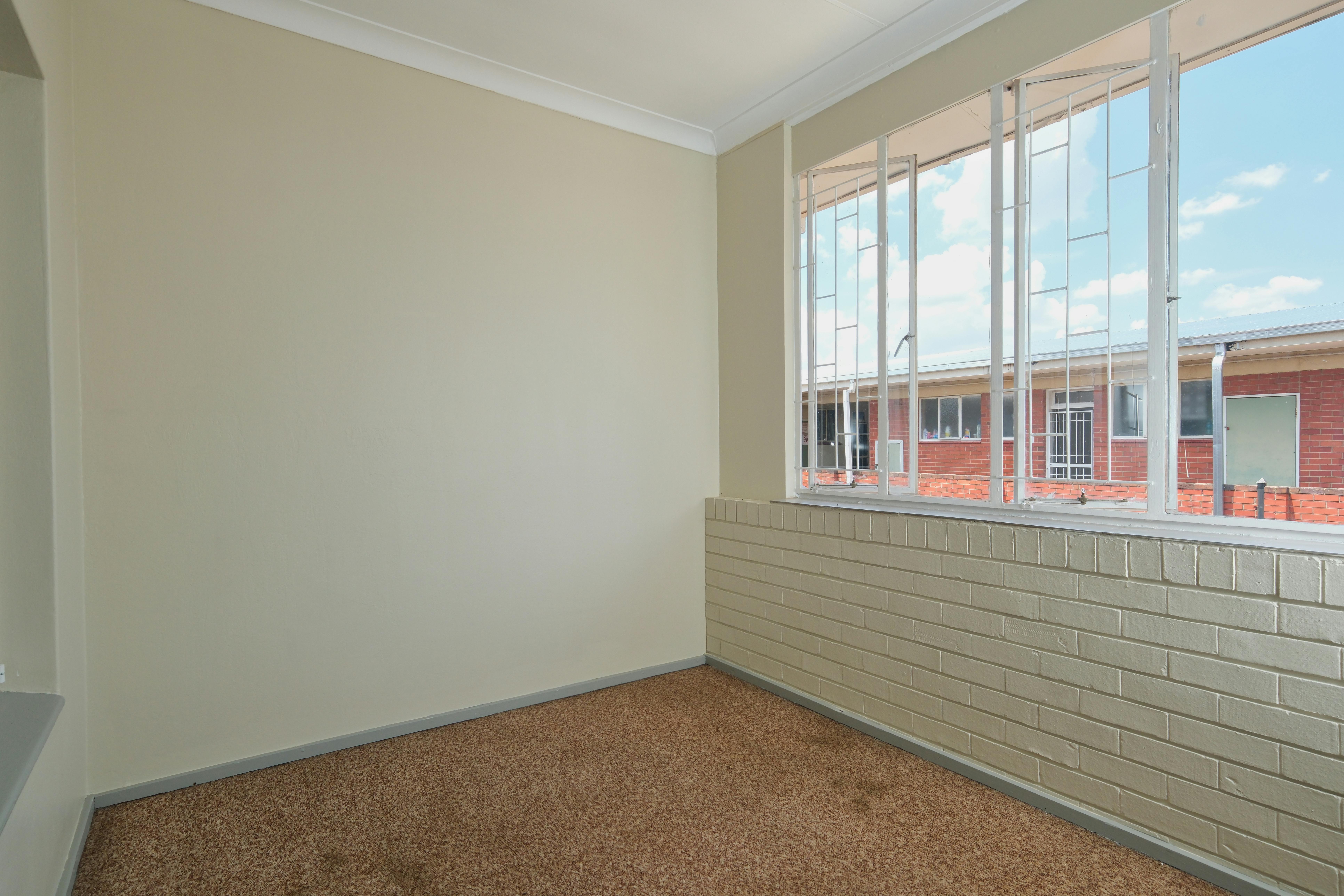Empty Room with Large Windows Overlooking Building Exterior · Free ...