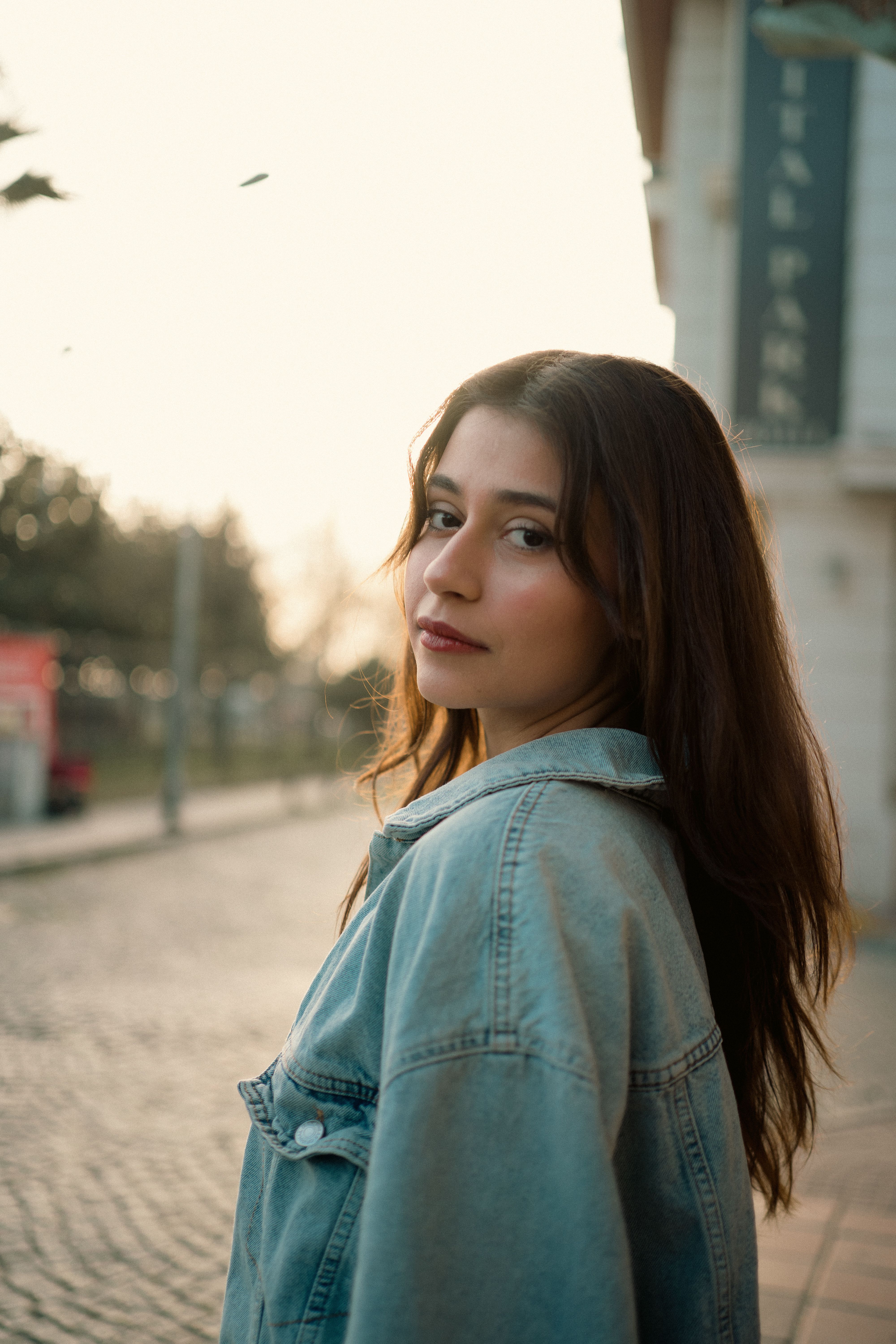 Young Woman Walking Down a Cobblestone Street · Free Stock Photo