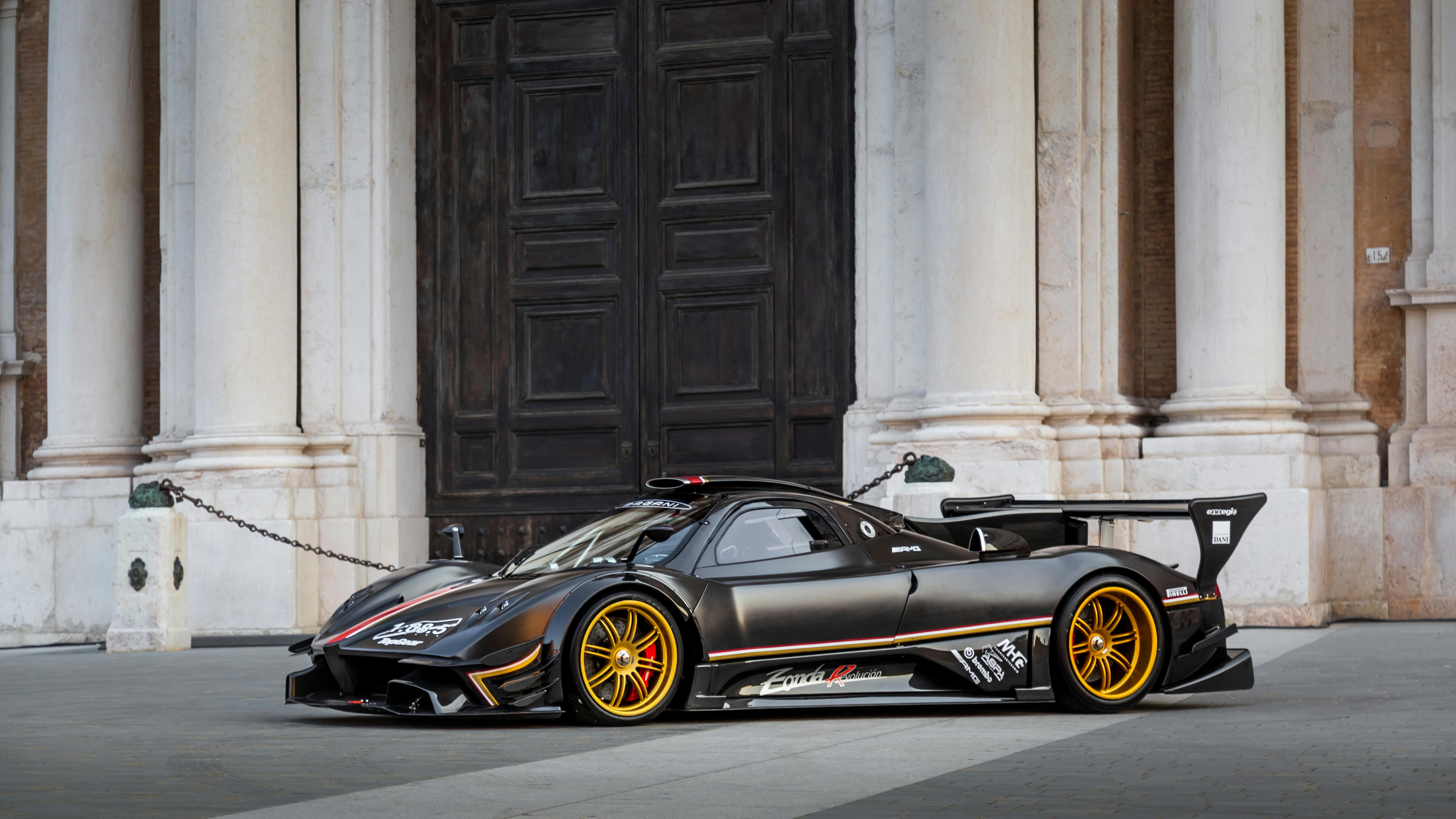 Sleek Black Hypercar Parked Outside Architectural Venue · Free Stock Photo