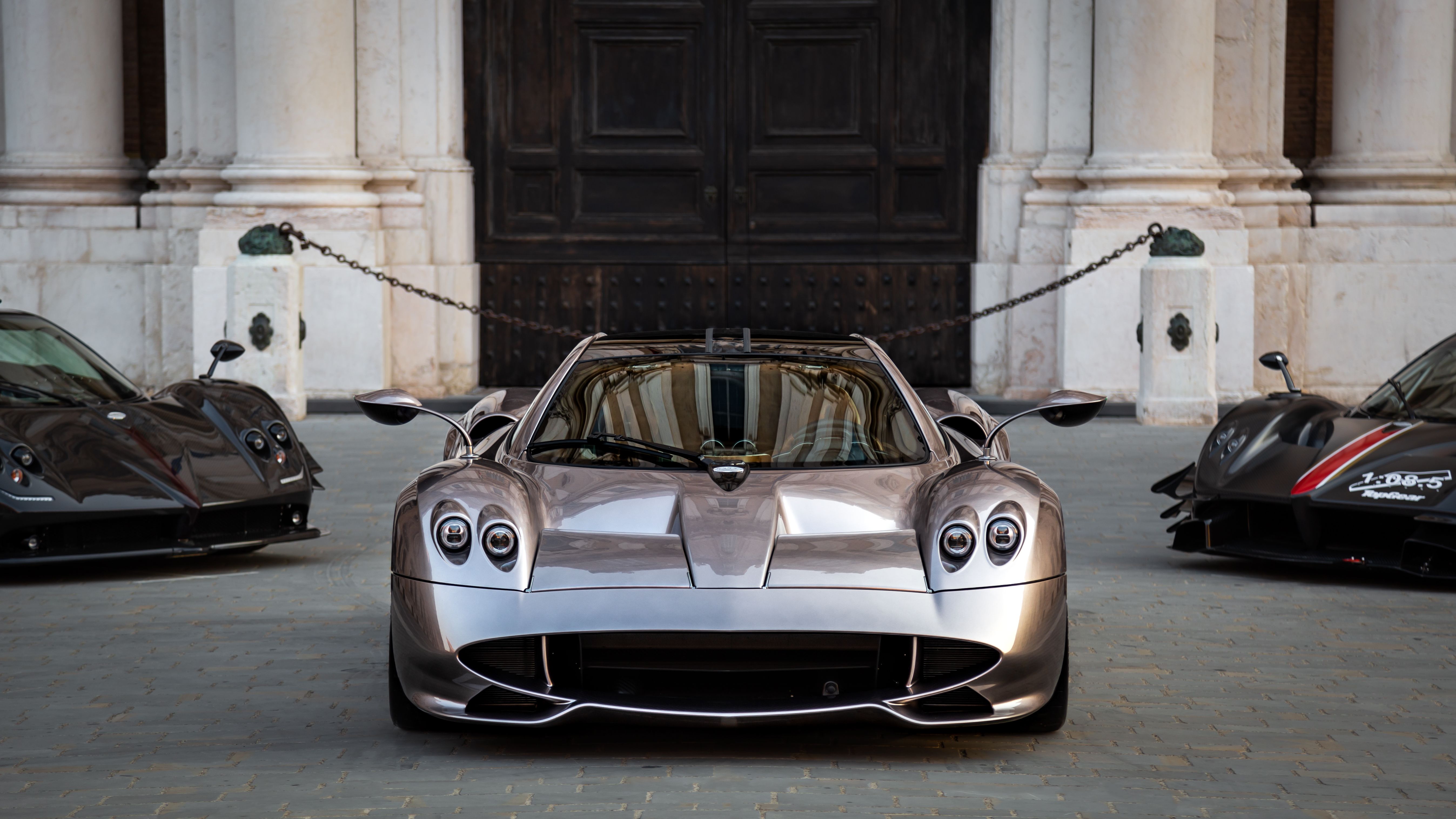 Luxurious Supercars Displayed in Elegant Courtyard · Free Stock Photo