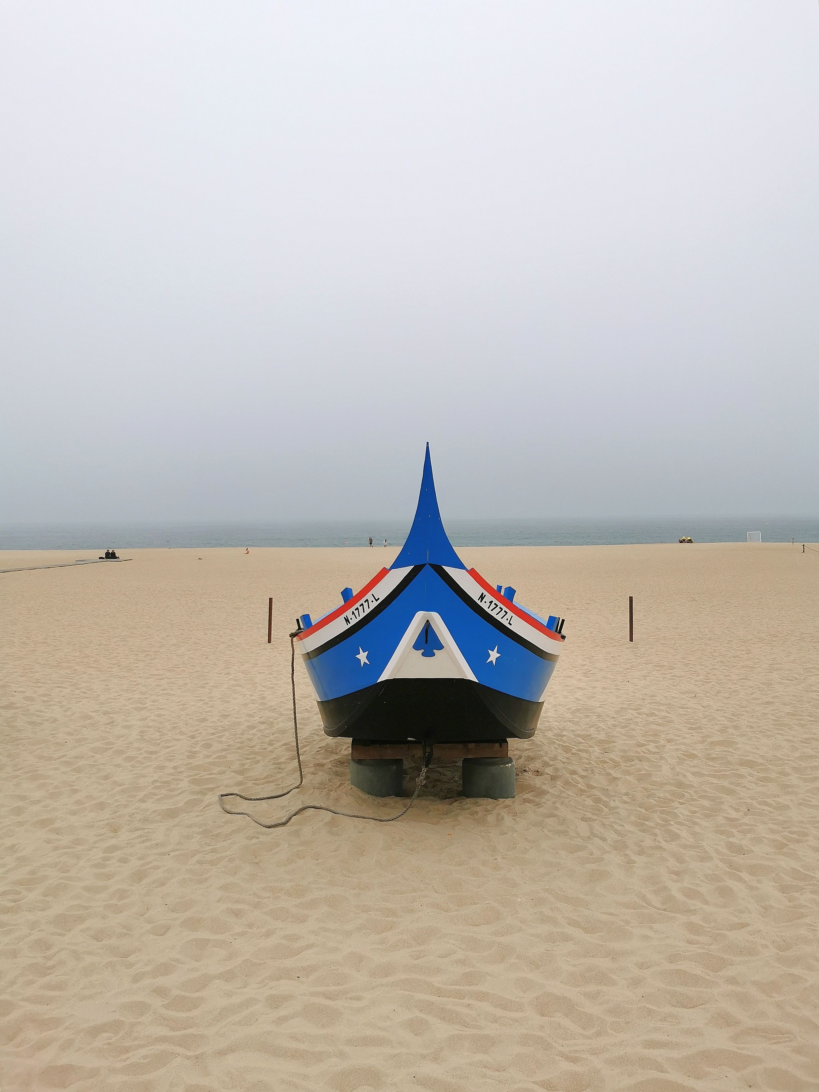 Traditional Blue Fishing Boat on Sandy Beach · Free Stock Photo