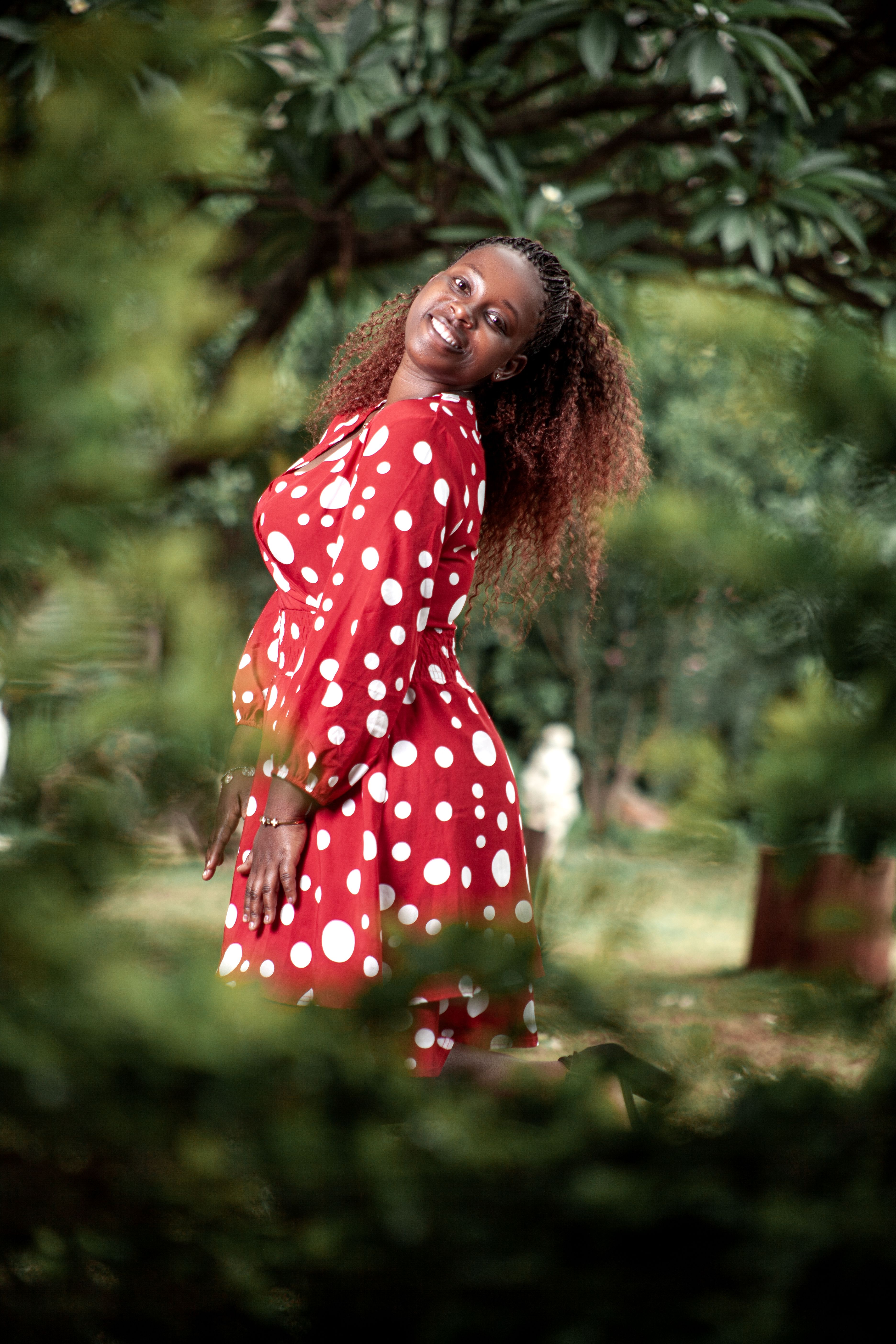 Joyful Woman in Red Polka Dot Dress Outdoors · Free Stock Photo