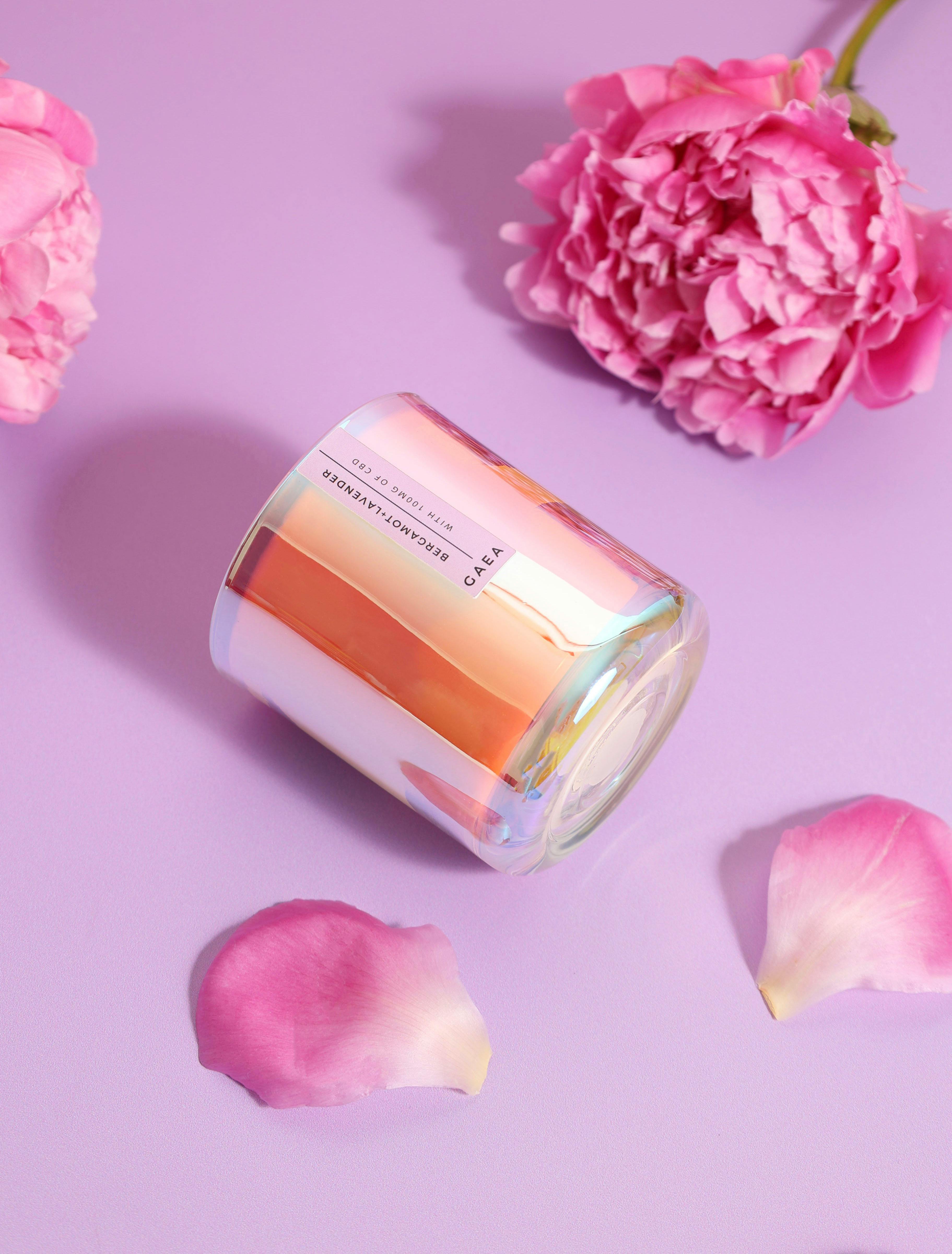 Elegant CBD Infused Candle on Lavender Background · Free Stock Photo