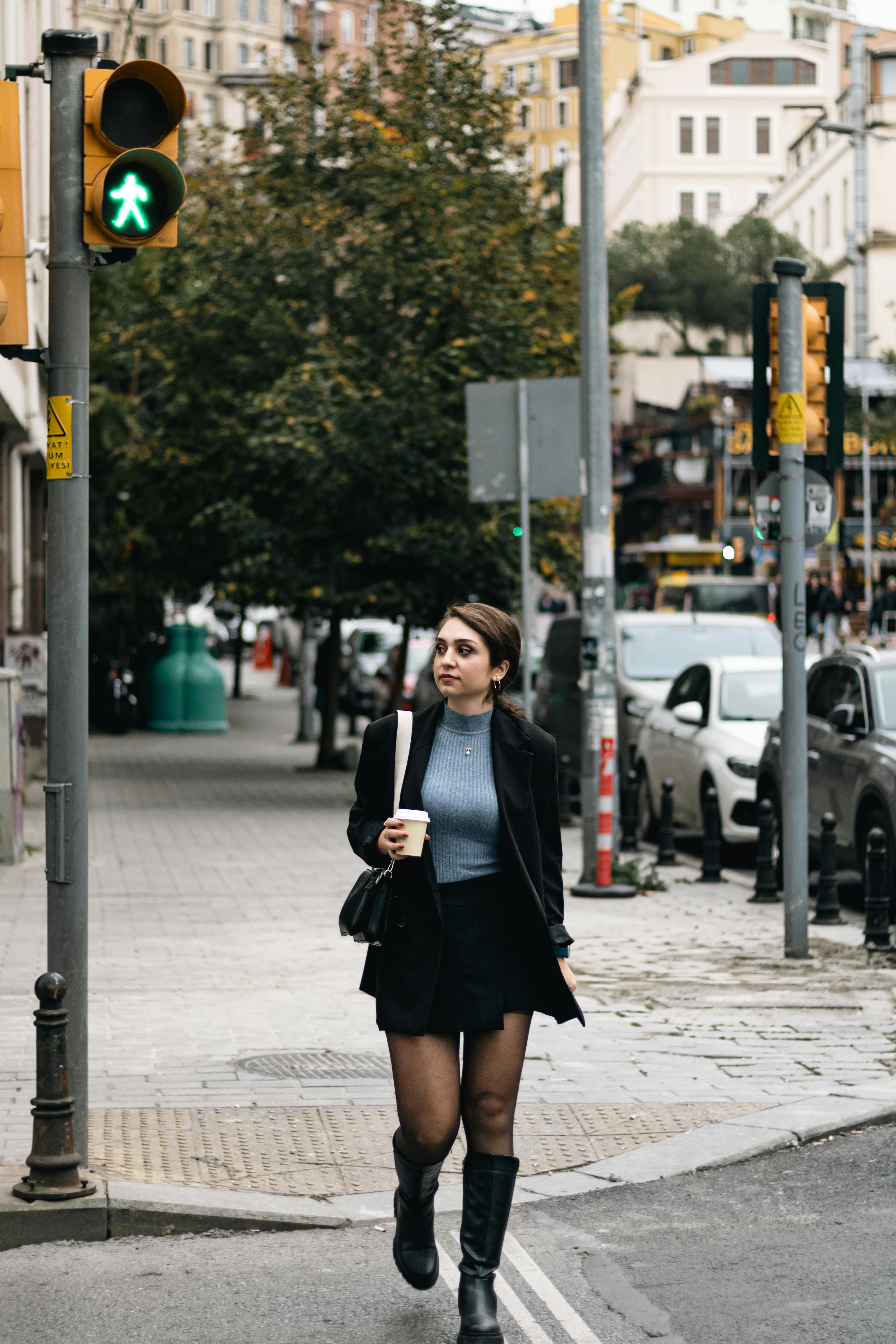 Woman crossing urban street at green light · Free Stock Photo