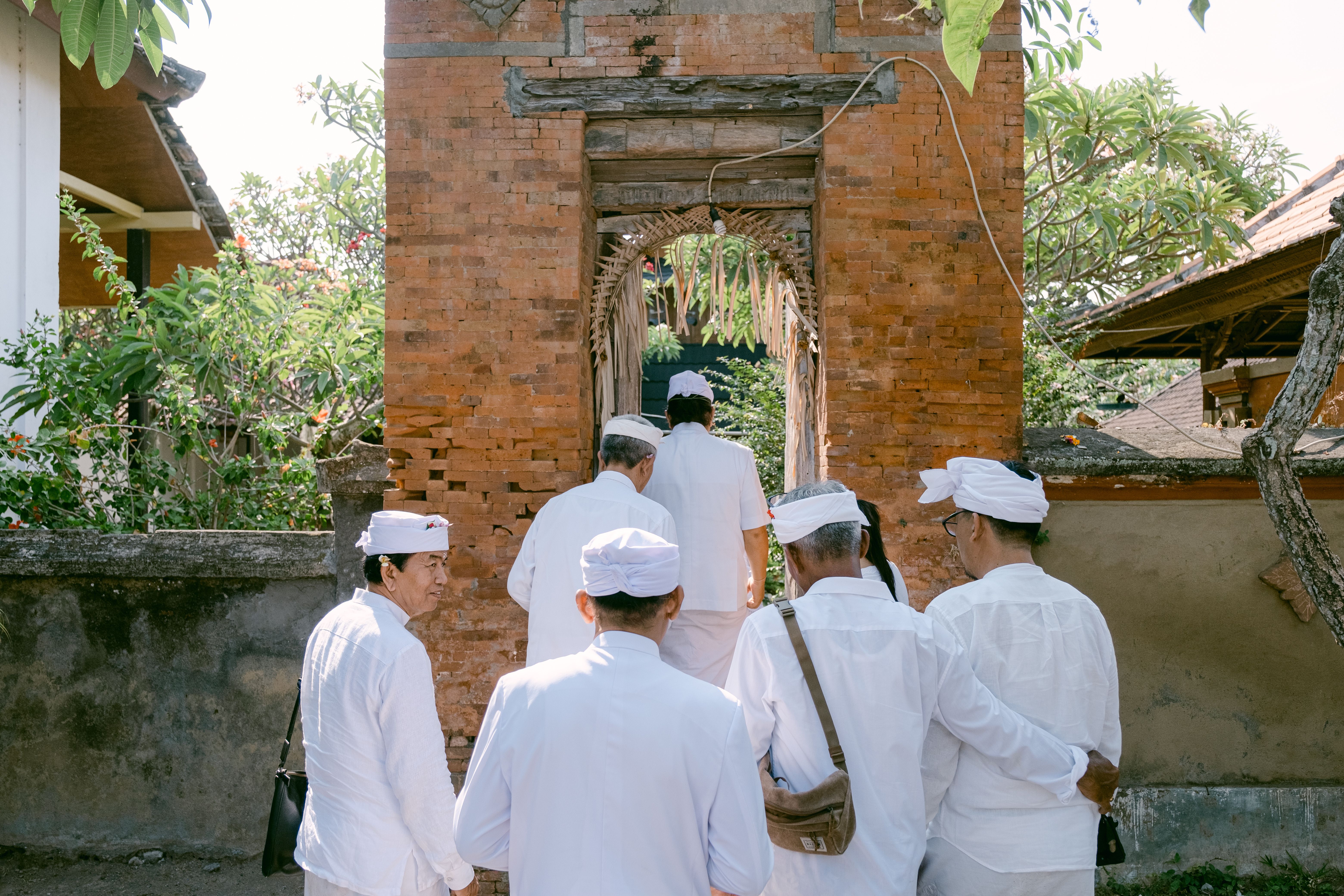 Cultural Ceremony with Balinese Men in White Attire · Free Stock Photo