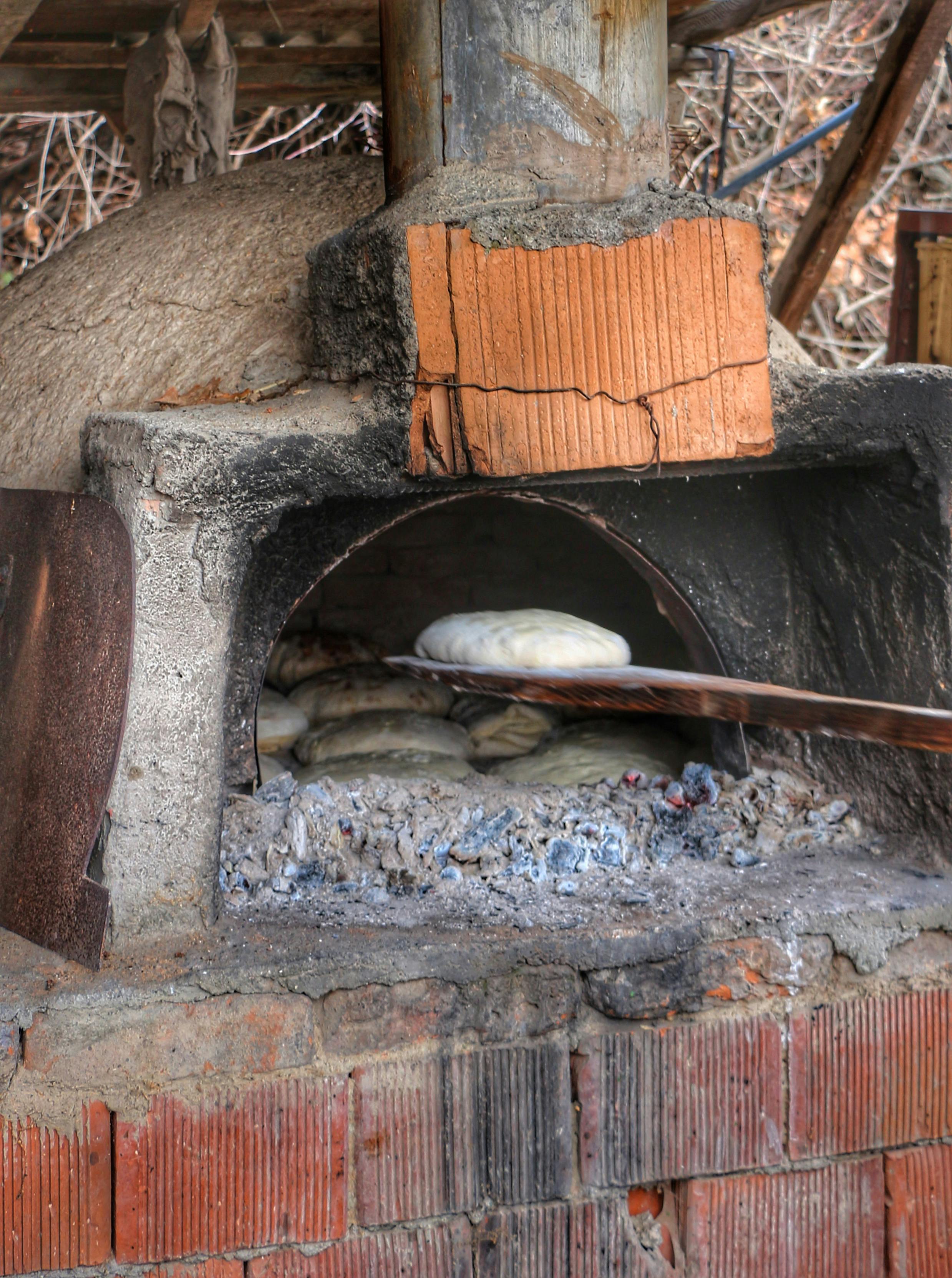 Rustic Wood-Fired Bread Oven in Action · Free Stock Photo