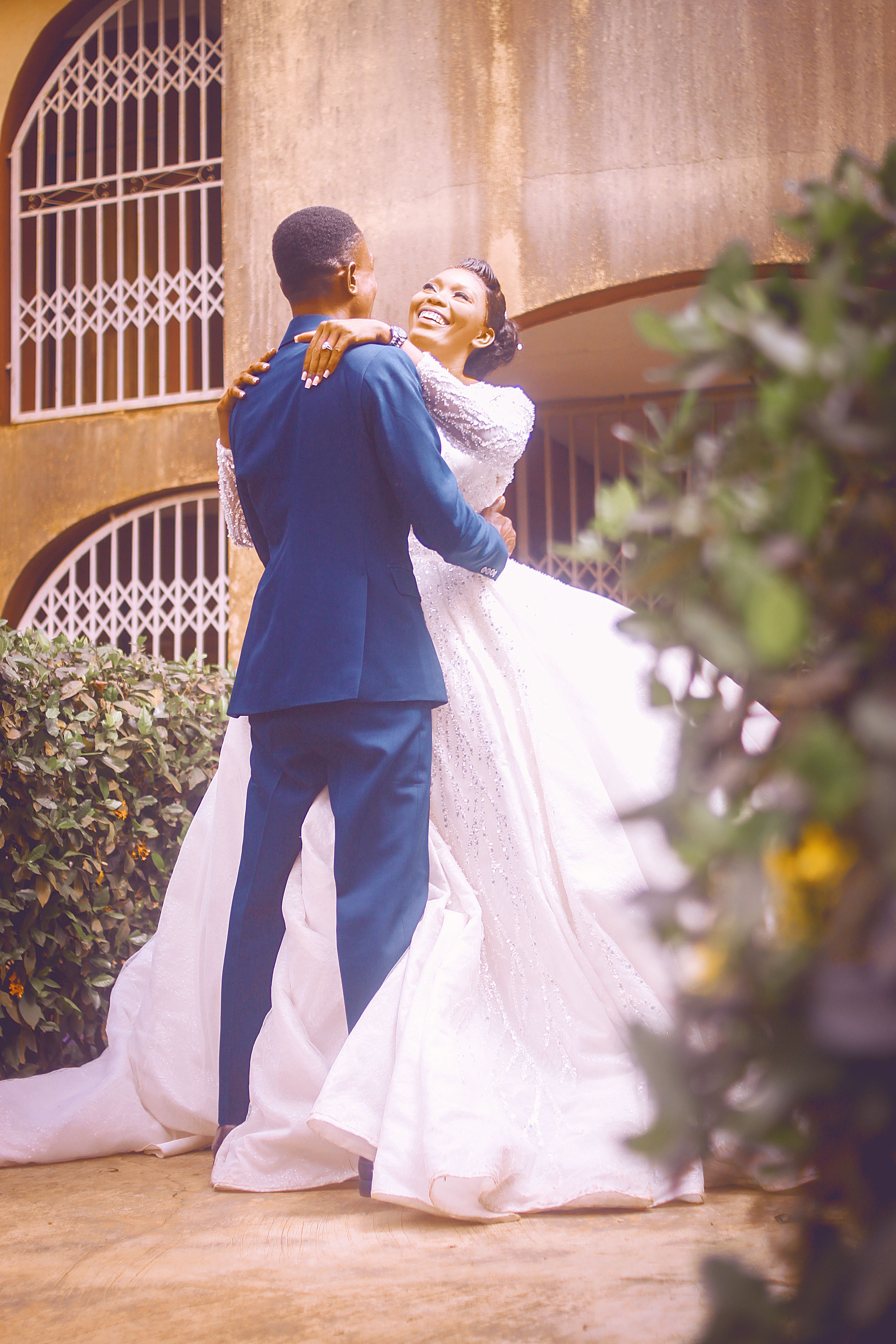 Joyful Wedding Couple Embracing Outdoors · Free Stock Photo