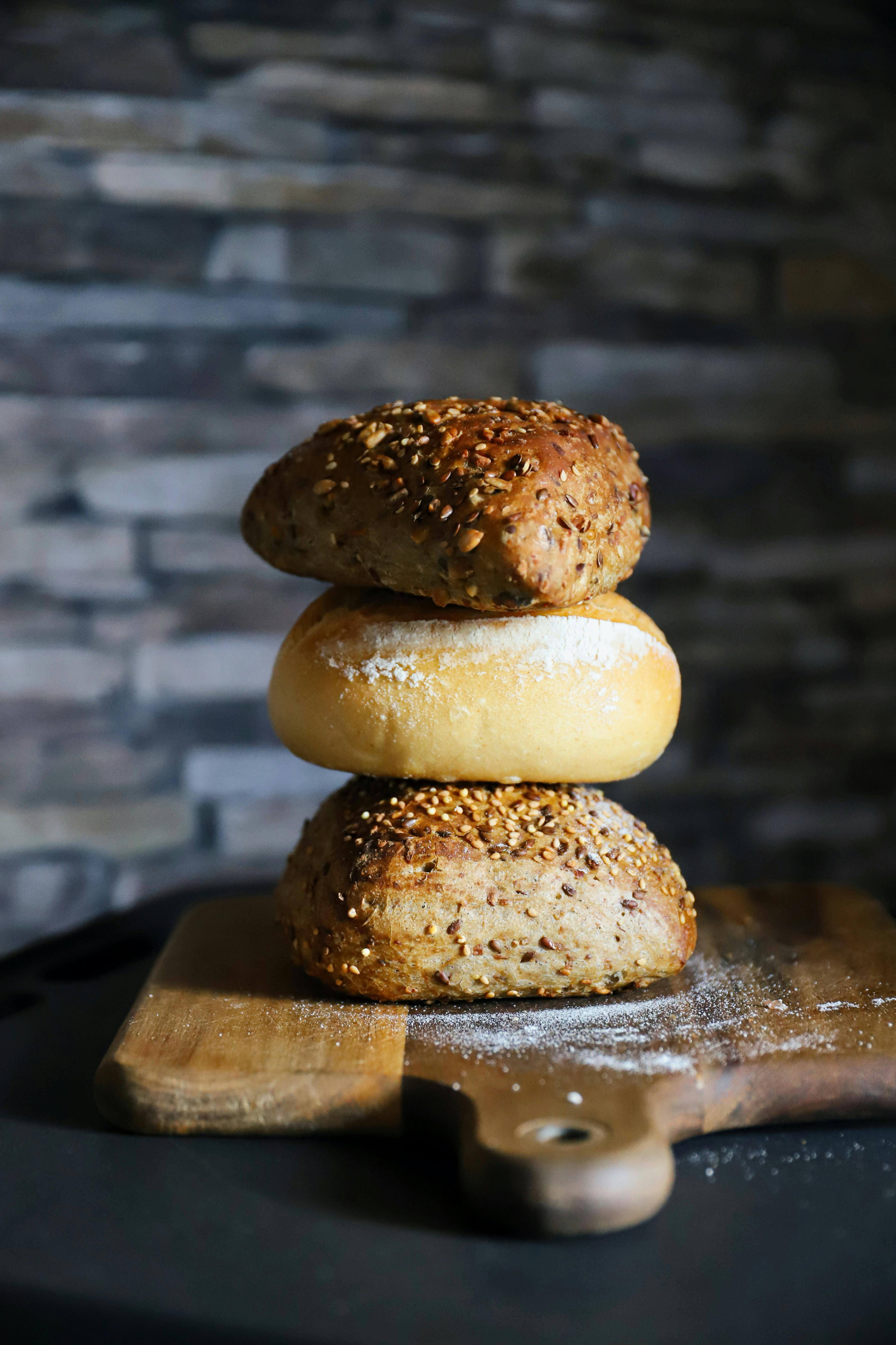 Freshly Baked Bread Rolls Stacked on Board · Free Stock Photo