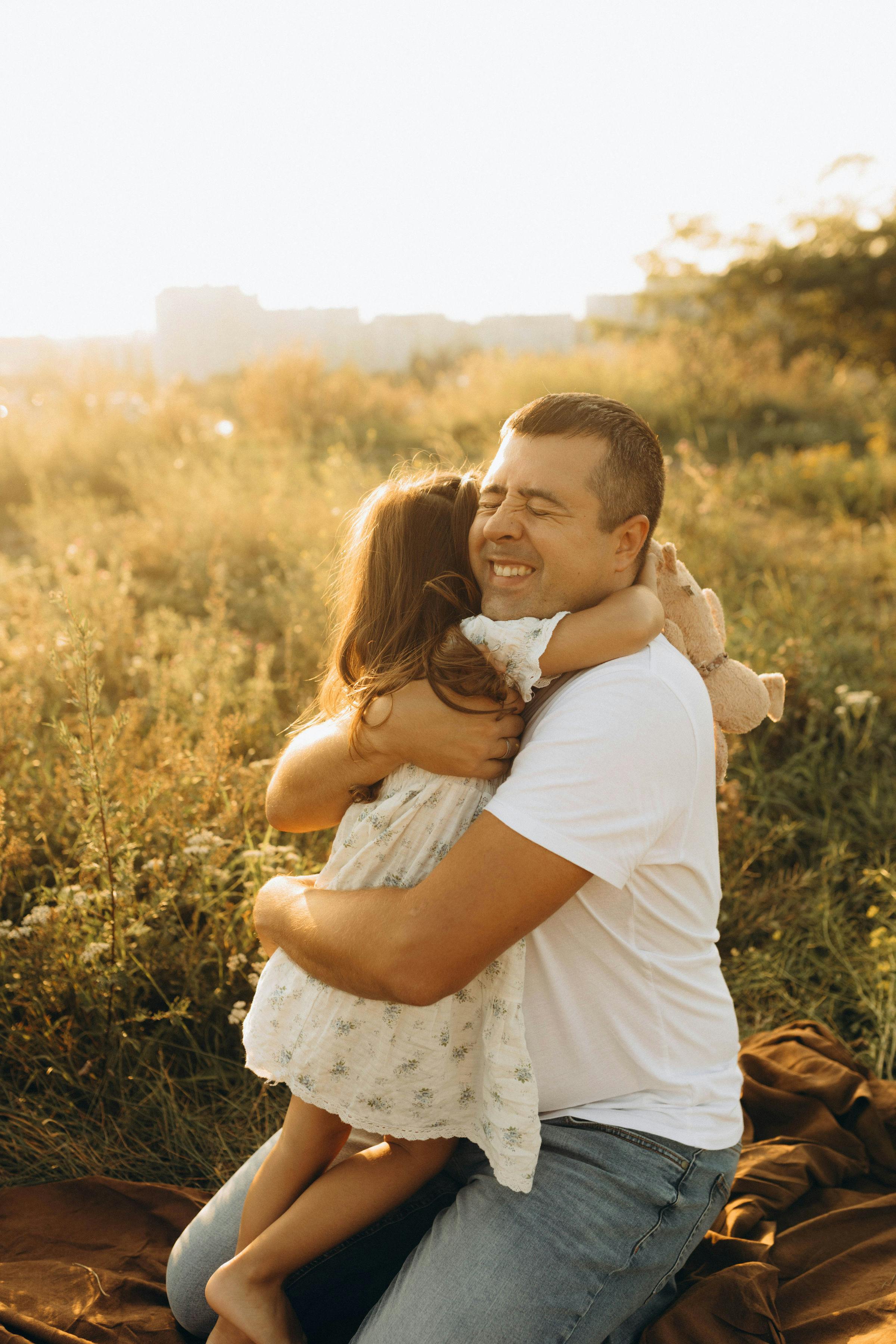 Heartfelt Father and Daughter Hug in Nature · Free Stock Photo