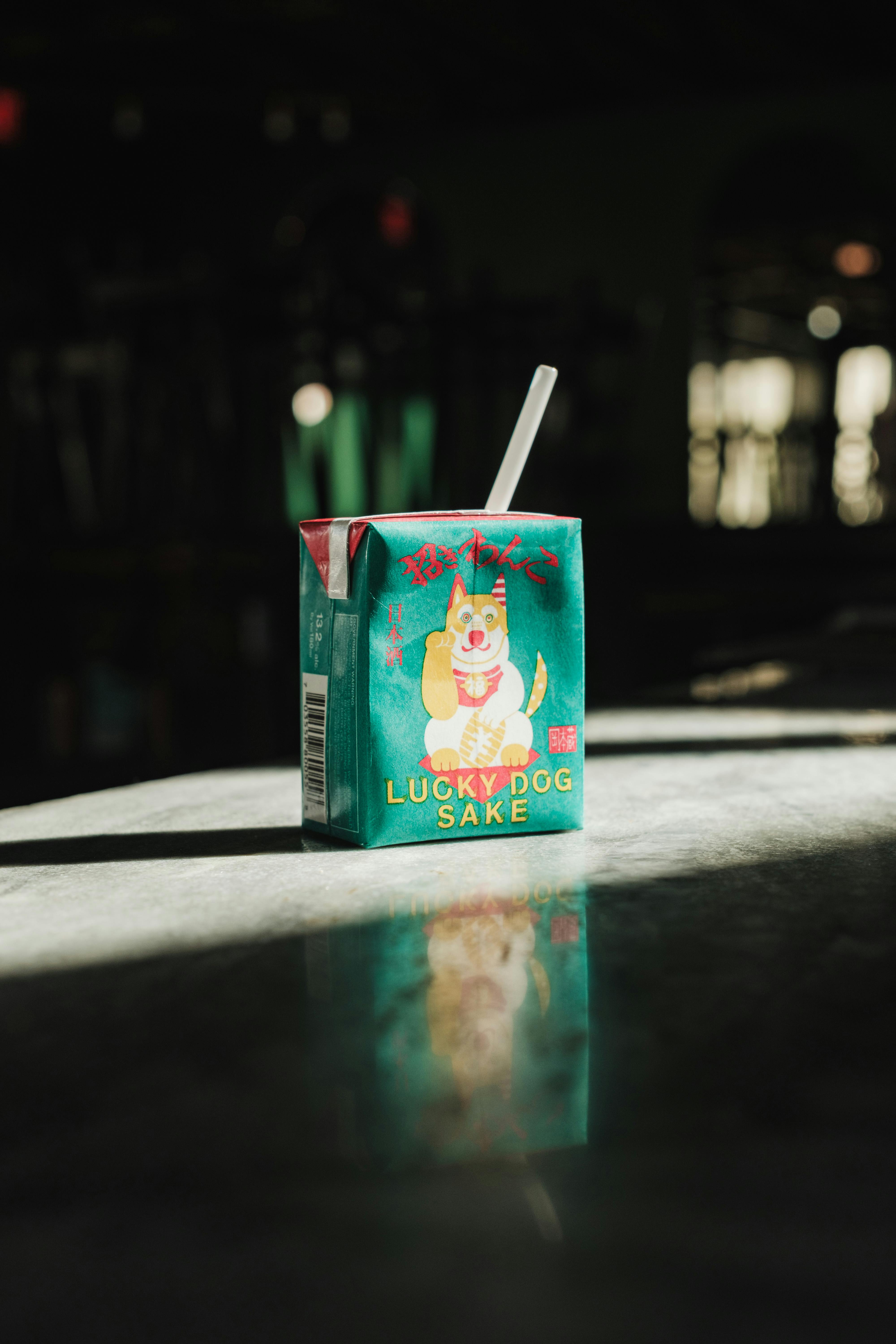 Lucky Dog Sake Carton in a Sunlit Room · Free Stock Photo