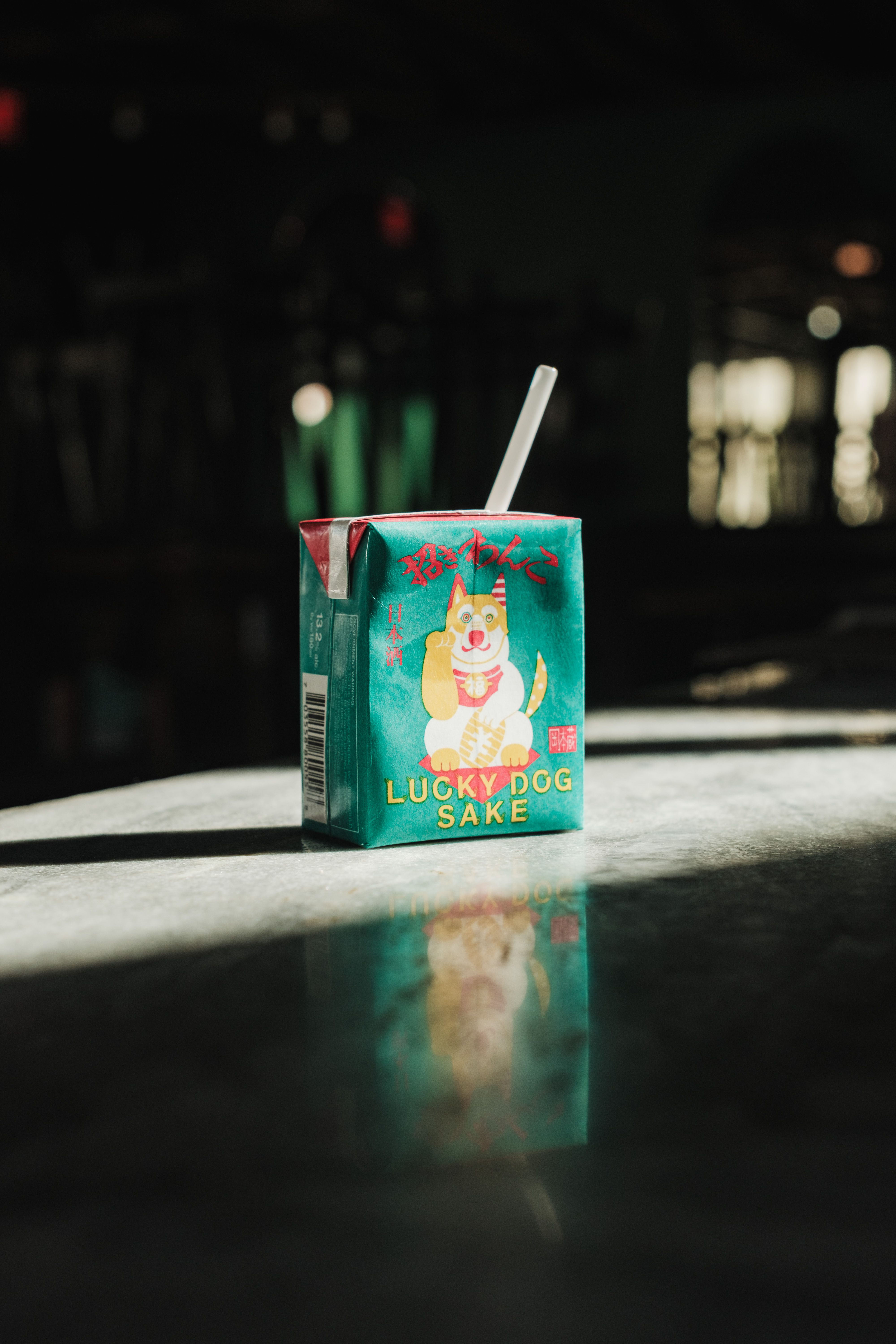 Lucky Dog Sake Carton in a Sunlit Room · Free Stock Photo